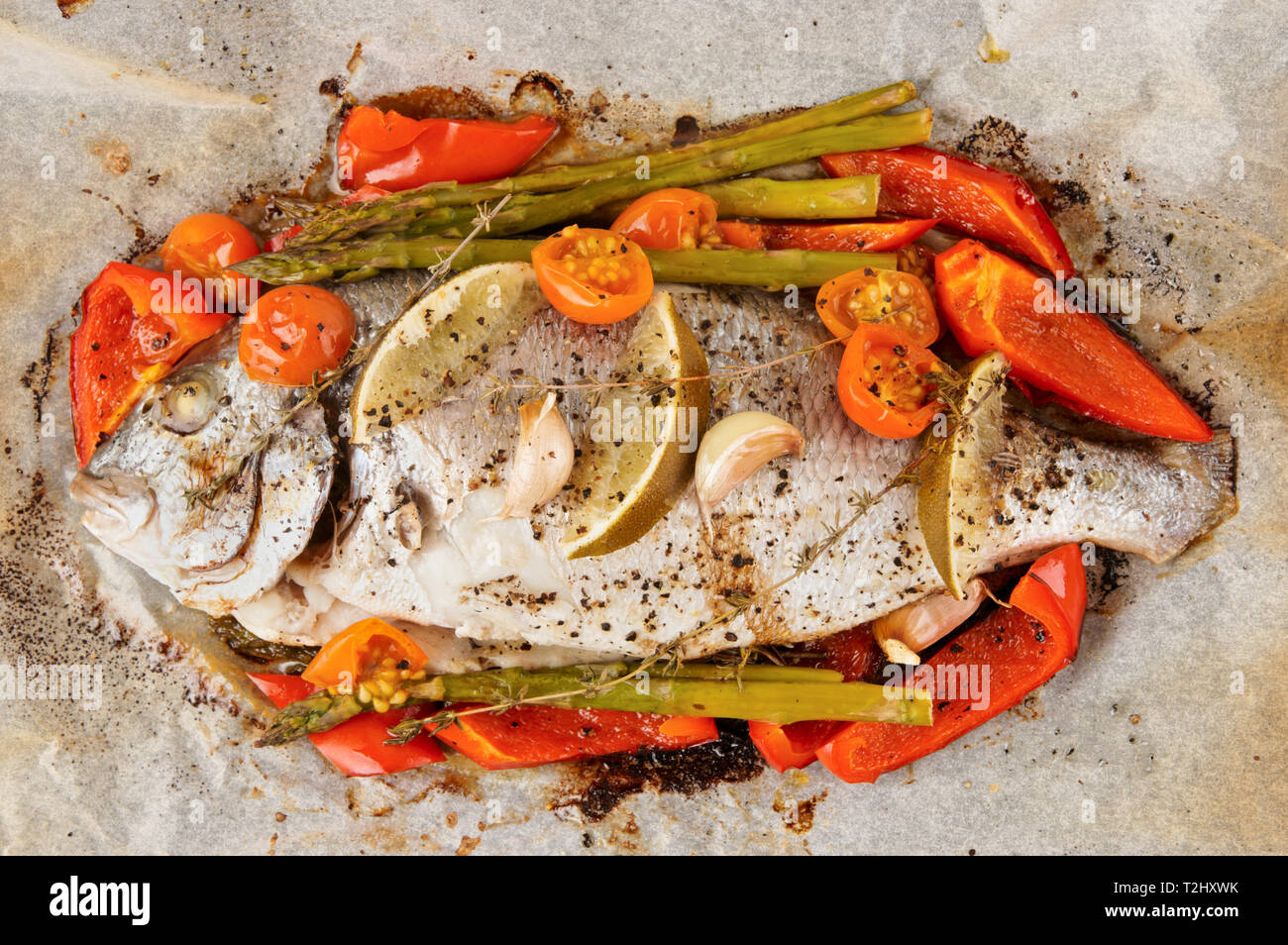 Dorade with vegetables roasted in culinary paper shot from above Stock ...