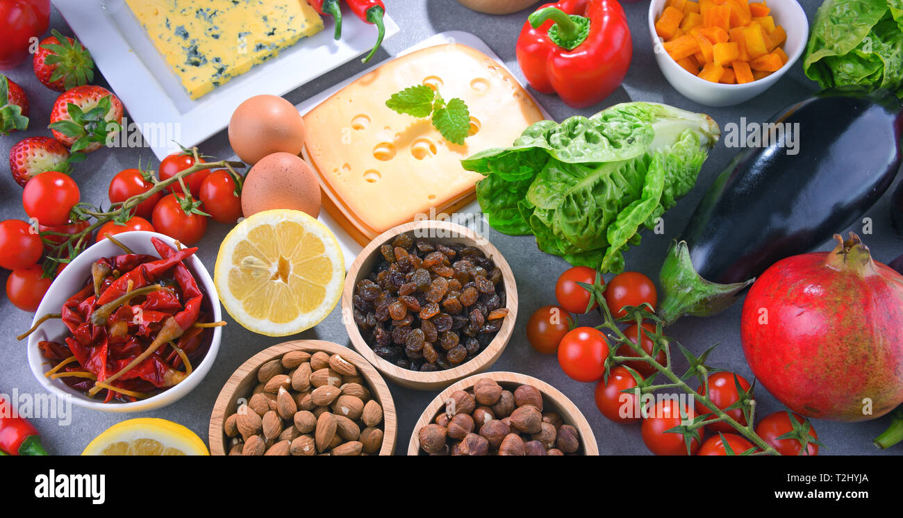 Composition with assorted organic food products on wooden kitchen table ...