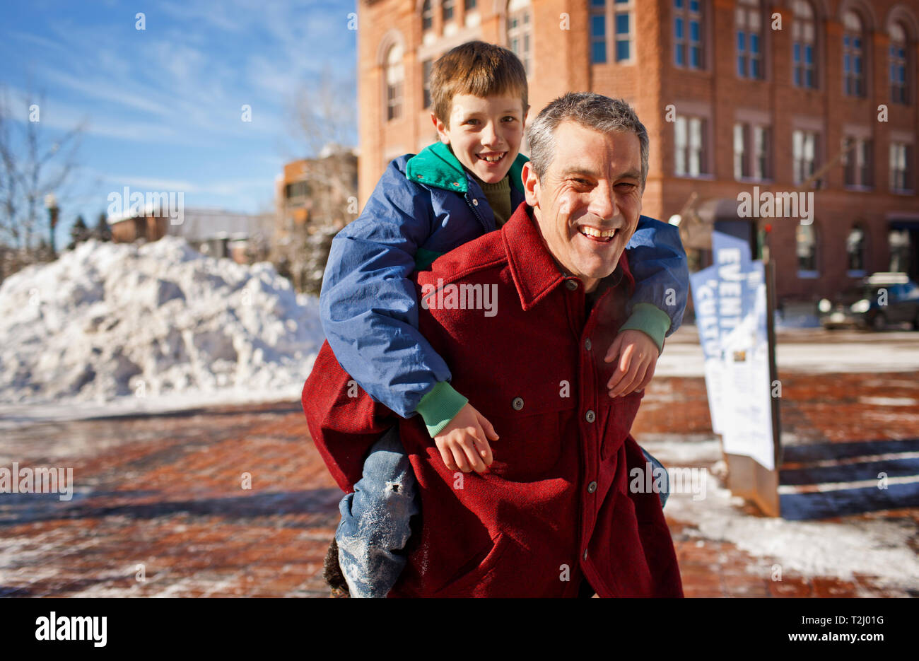 Portrait of a father giving his son a piggyback ride Stock Photo - Alamy
