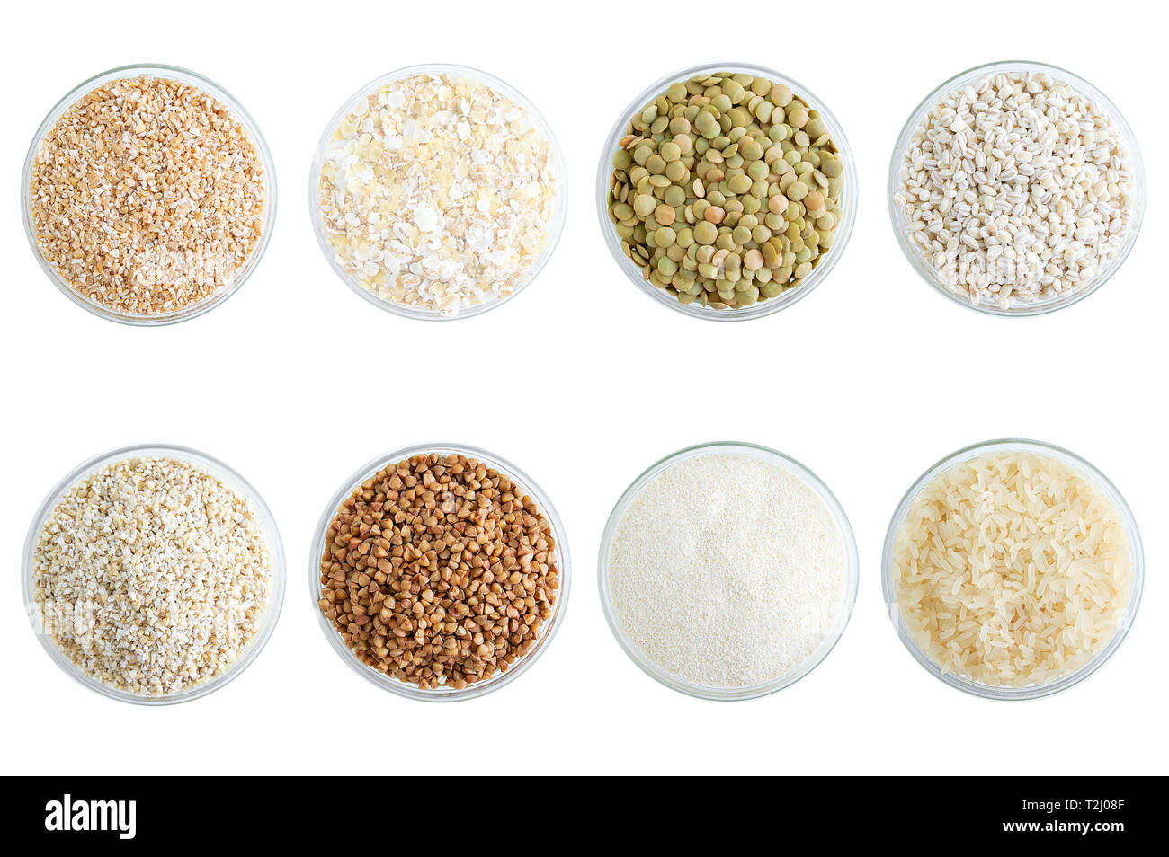 Different types of cereals in glassware. View from above. White isolate ...