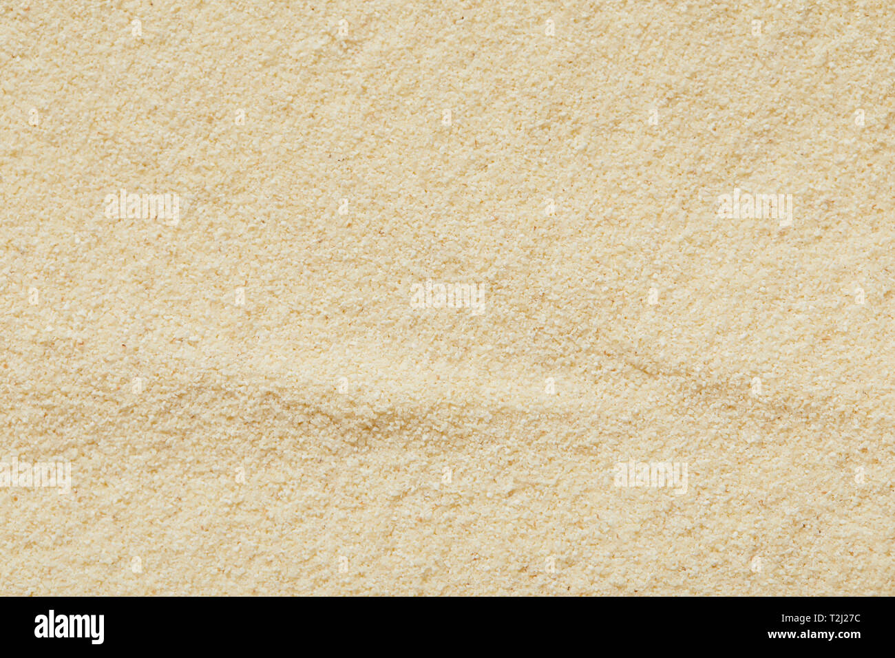 top view of golden and textured sandy surface on beach in summertime ...