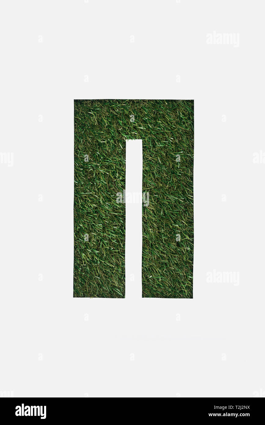 top view of cyrillic letter with green grass on background isolated on ...