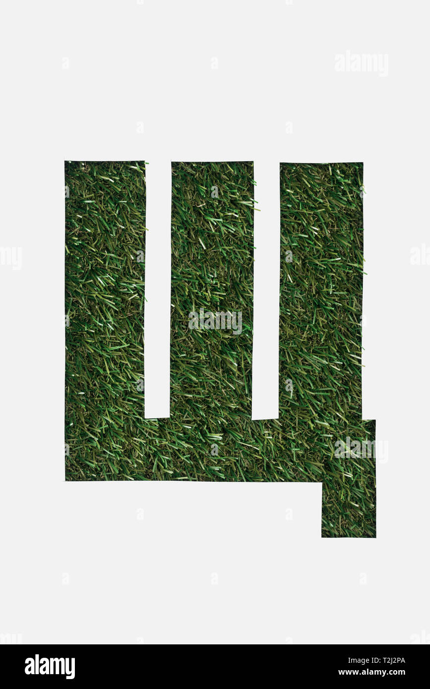 top view of cyrillic letter with green grass on background isolated on ...
