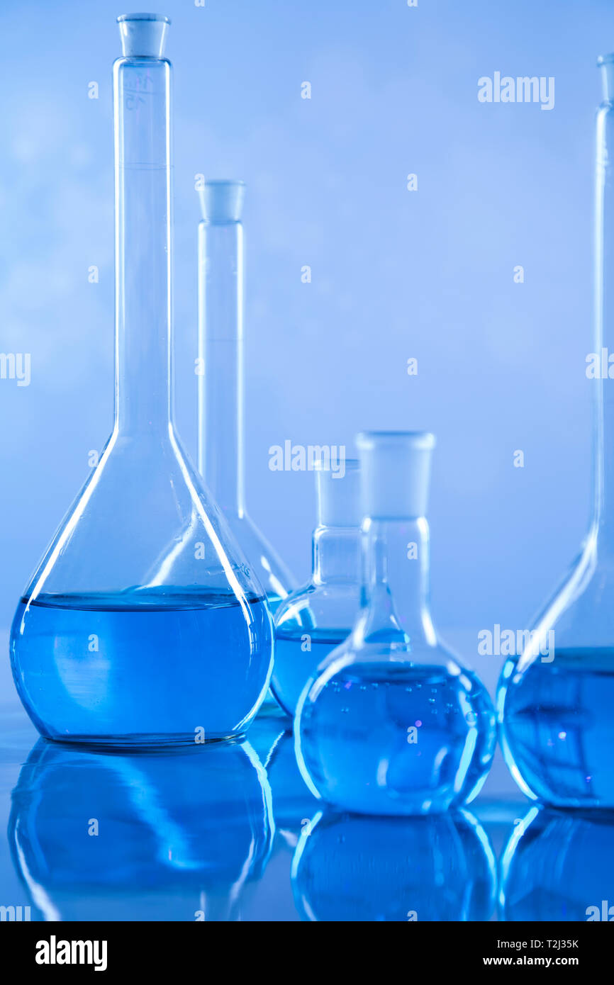 Laboratory beakers,Science experiment, blue background Stock Photo - Alamy