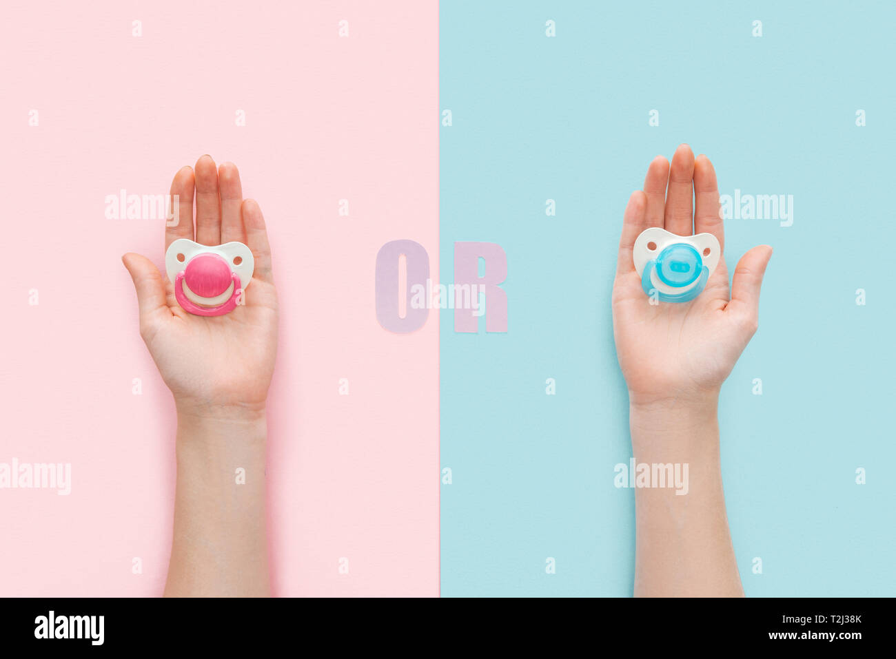 partial view of women holding pacifiers with or lettering on blue and ...