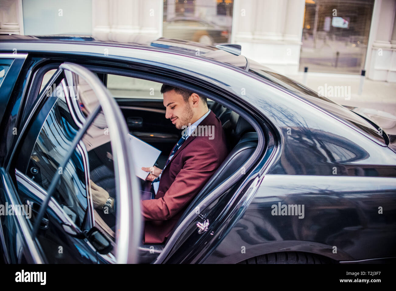 Handsome businessman sitting inside the luxury car Stock Photo - Alamy