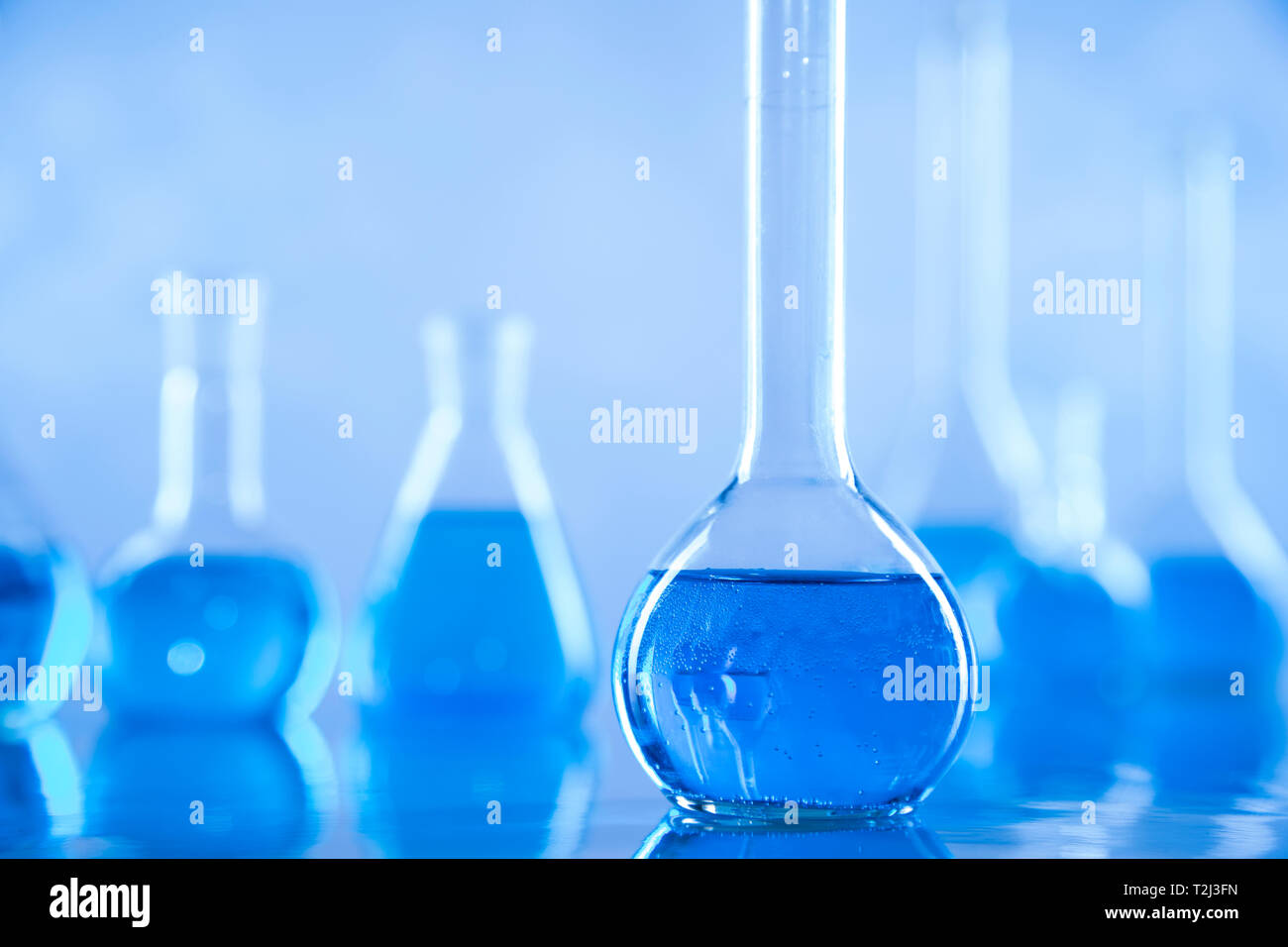 Laboratory beakers,Science experiment, blue background Stock Photo - Alamy