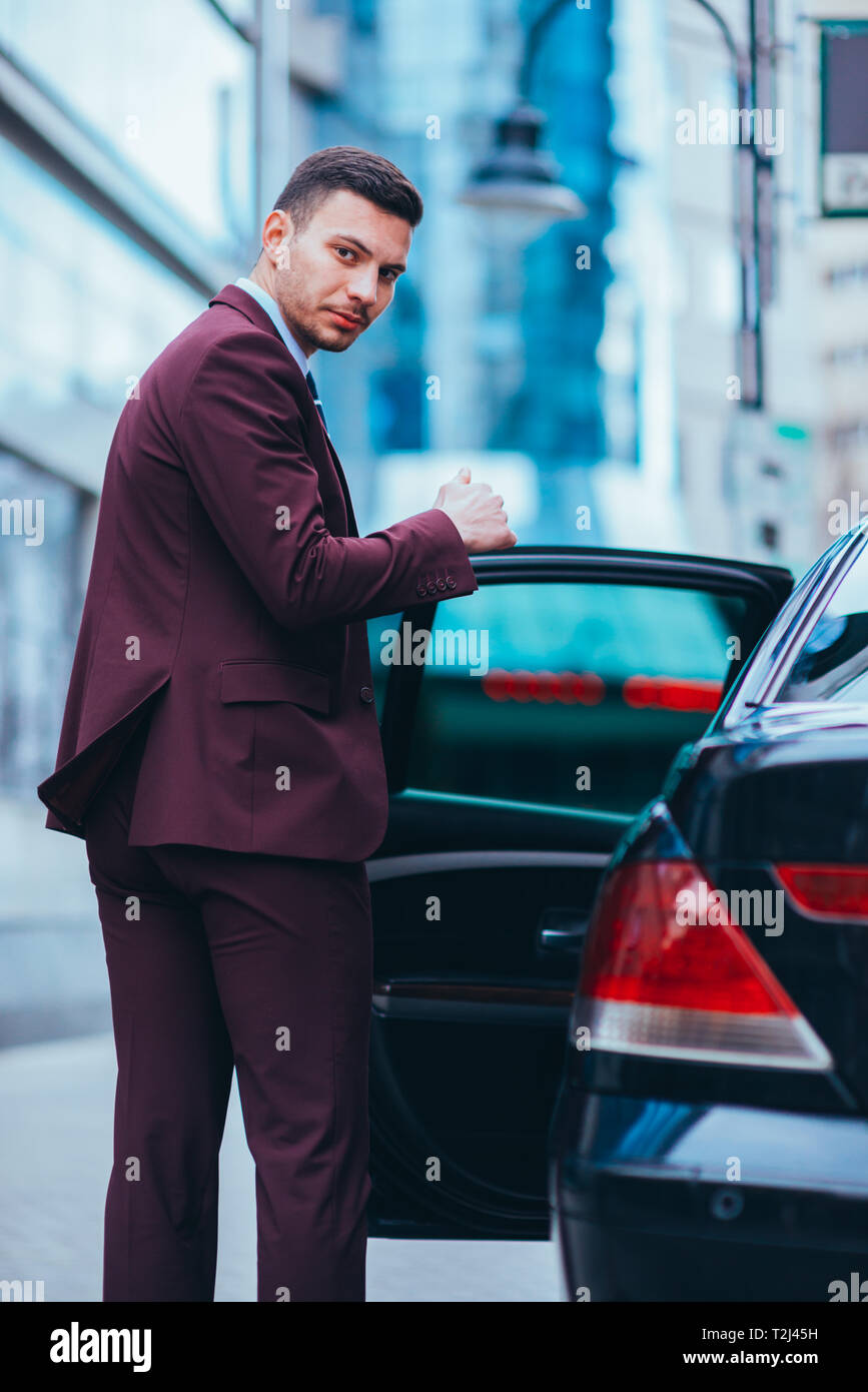 Suit black car exiting hi-res stock photography and images - Alamy