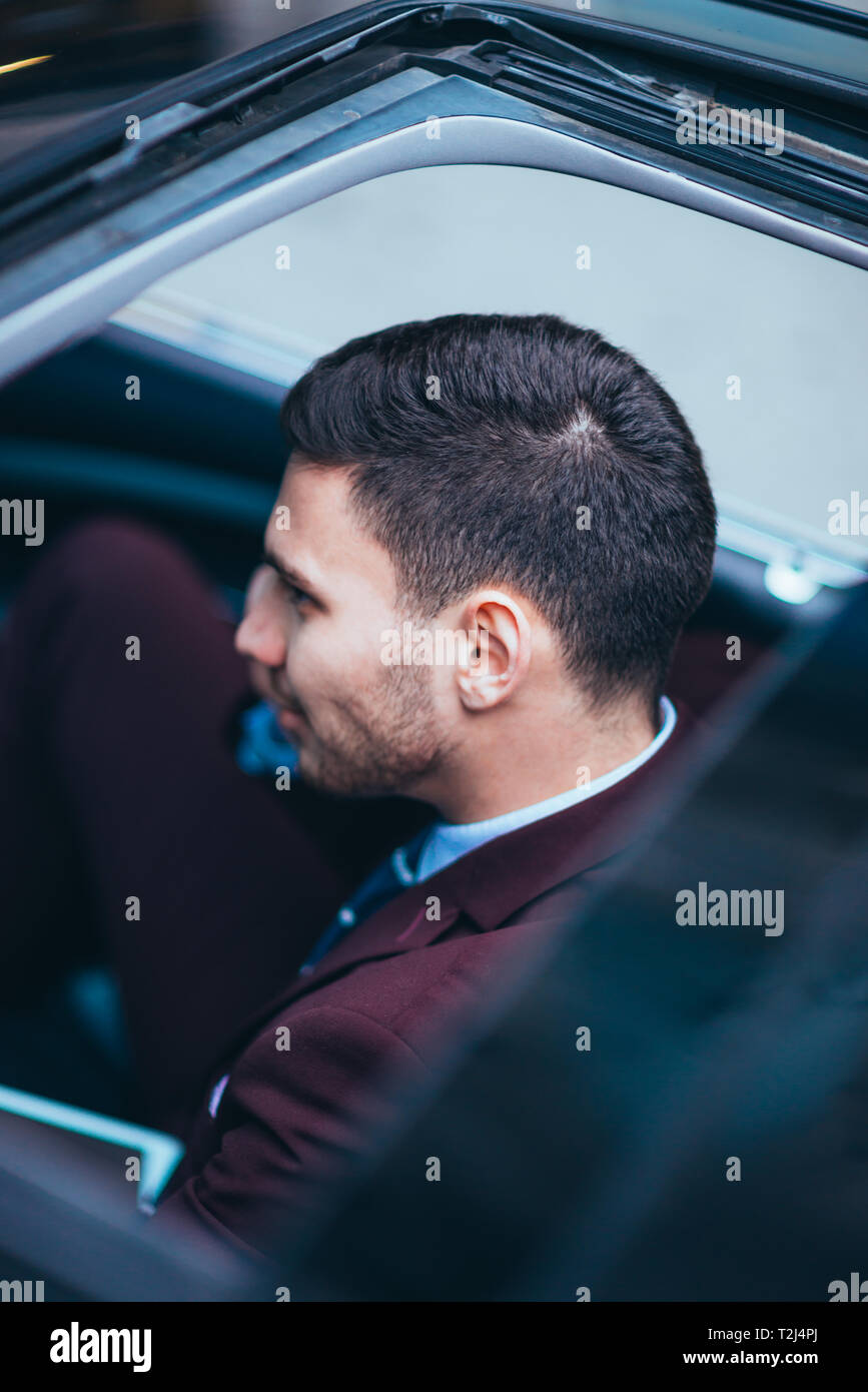 Above head perspective of a businessman working on his tablet while ...