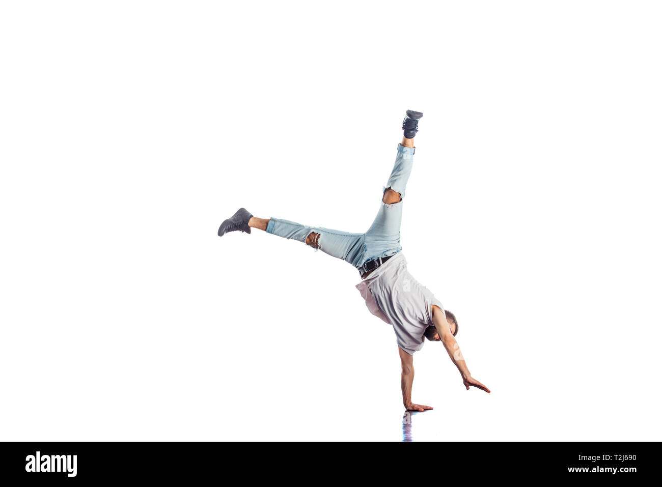 An urban guy is doing breakdance isolated on white wall Stock Photo - Alamy