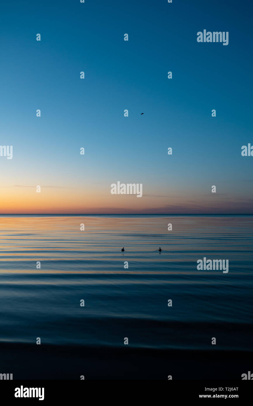 Vivid amazing sunset in Baltic States - Dusk in the sea with horizon ...