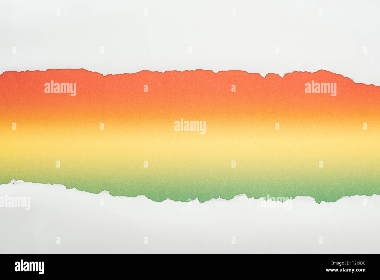 ragged white textured paper with copy space on multicolored background ...