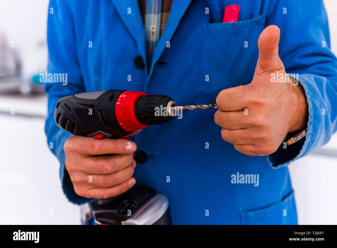 Old age workman holding his tool in the kitchen and working Stock Photo ...