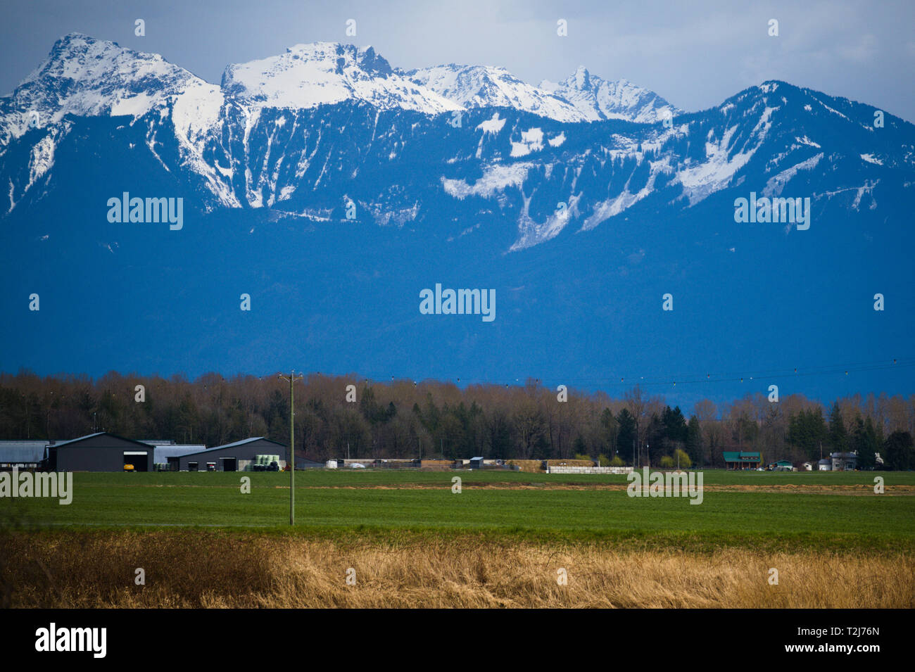 Mountains of the British Columbia coast range overlook farms in the ...