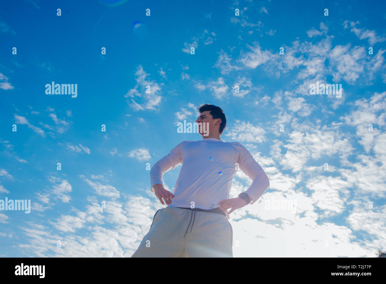 Bodybuilder performing his stretching routine in the morning on an ...