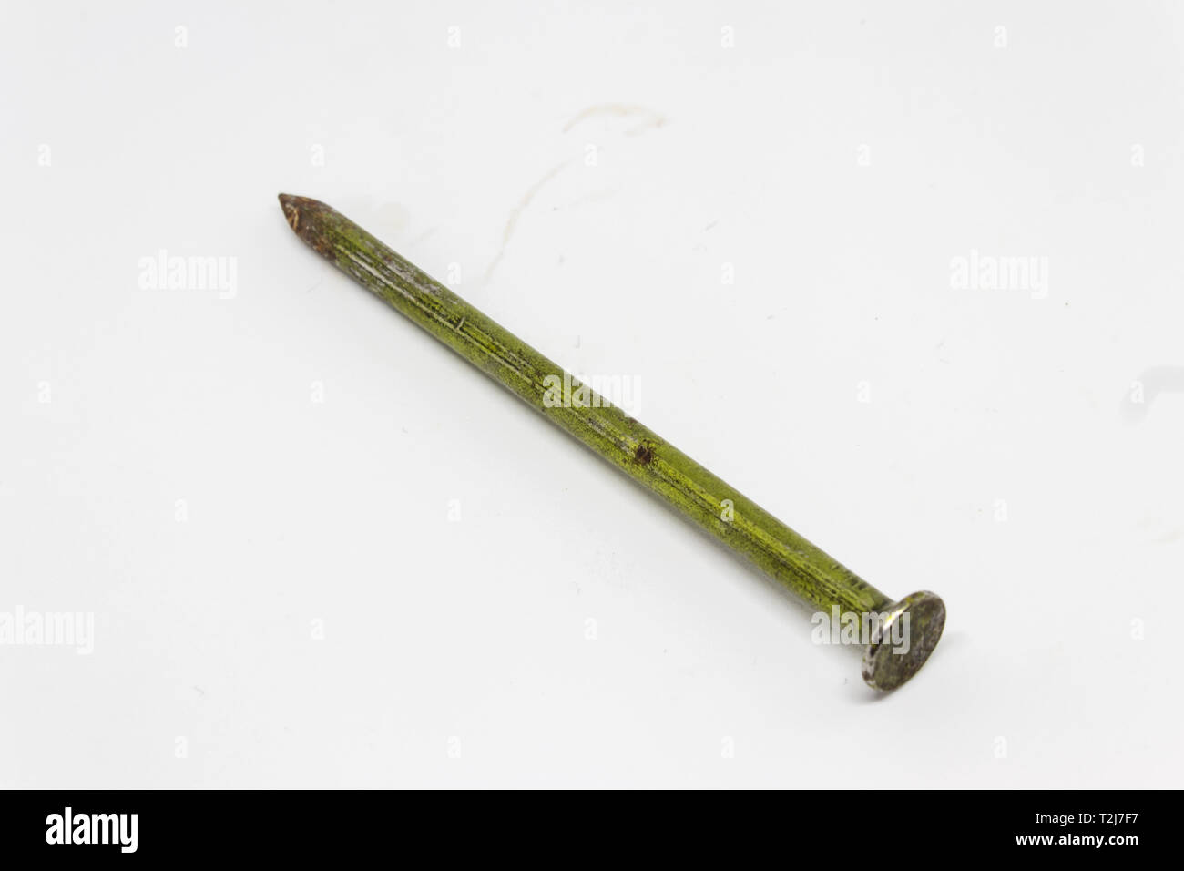 an old rusty nail closeup with white background. detailed product shoot ...