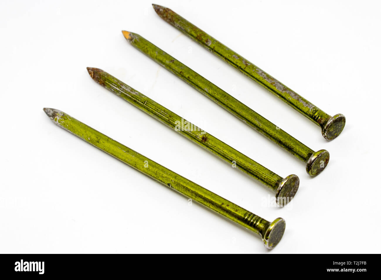 four old metal rusty nails closeup with white background. detailed ...