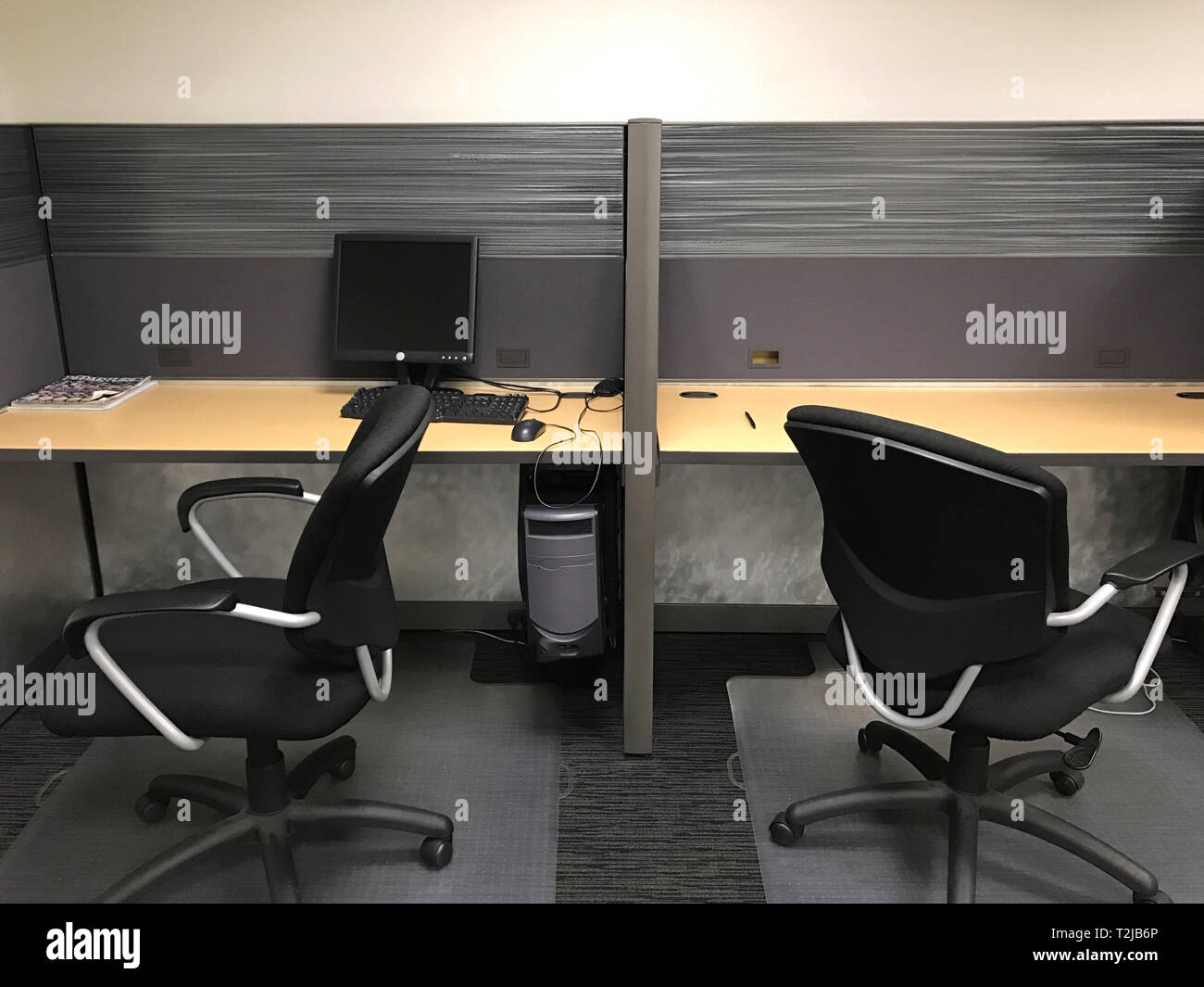 An empty office cubicle with chairs facing away from each other Stock ...