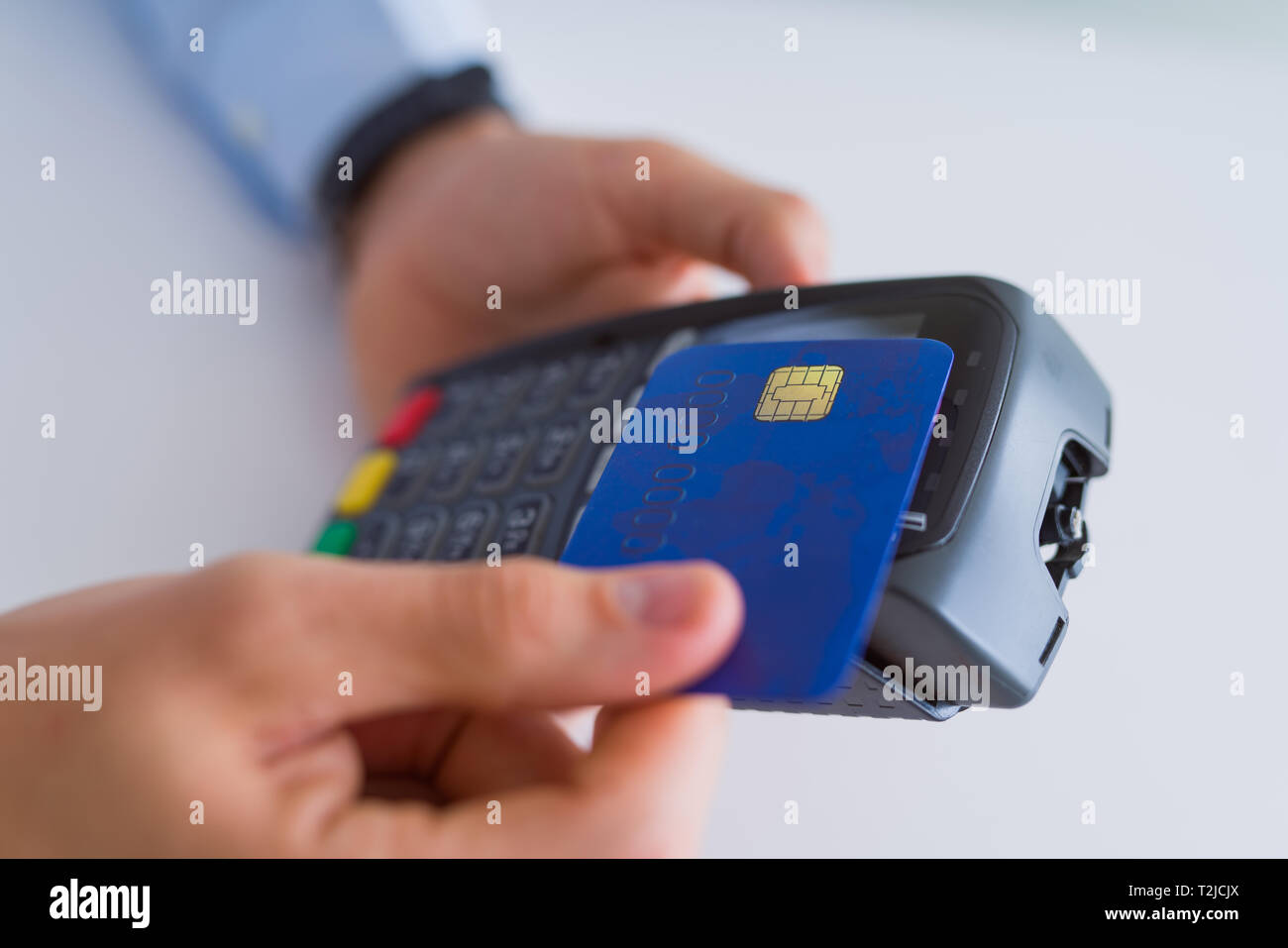 Close up of man hands holding pos terminal Stock Photo - Alamy