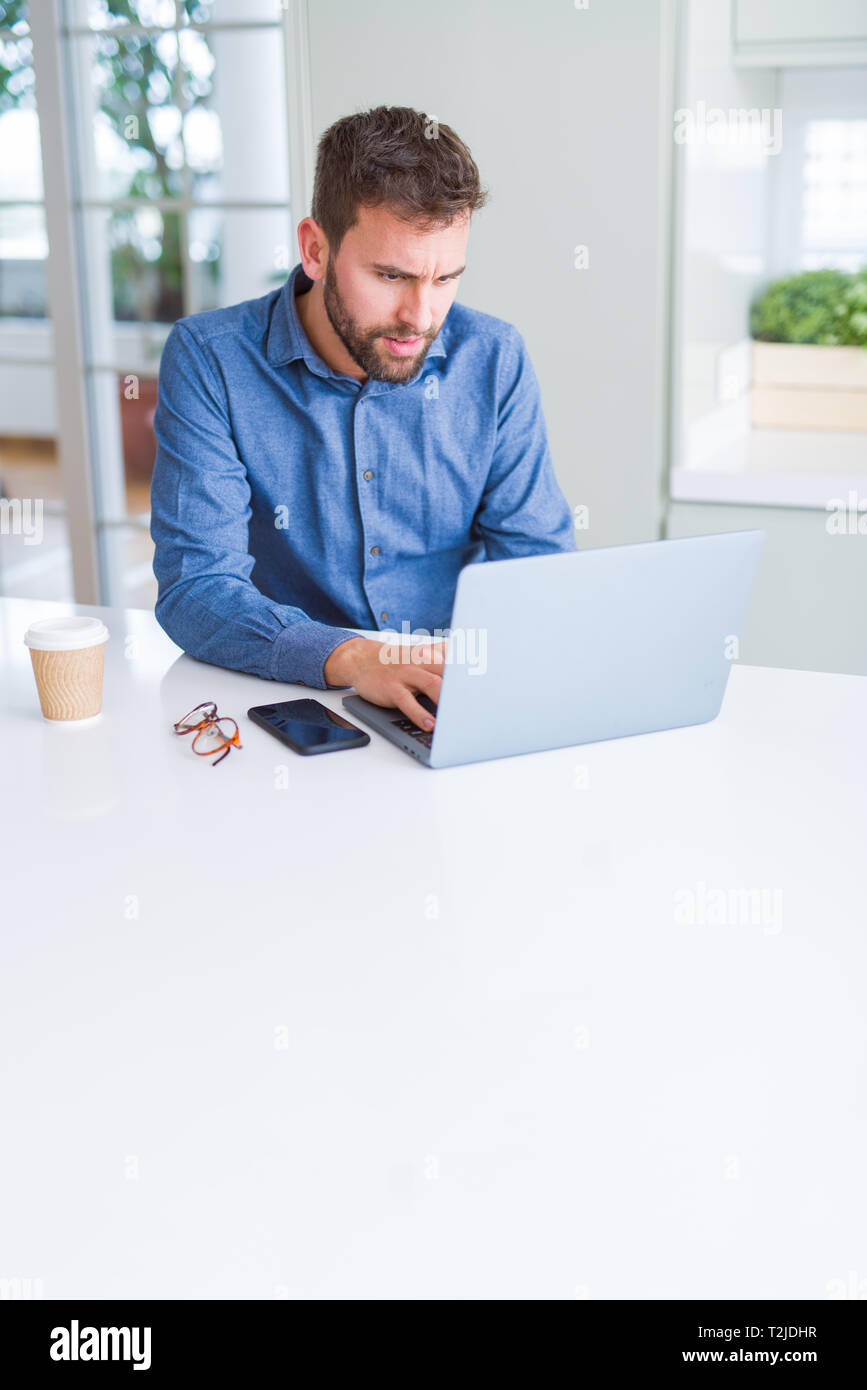 Handsome business man working using computer laptop and smiling Stock ...