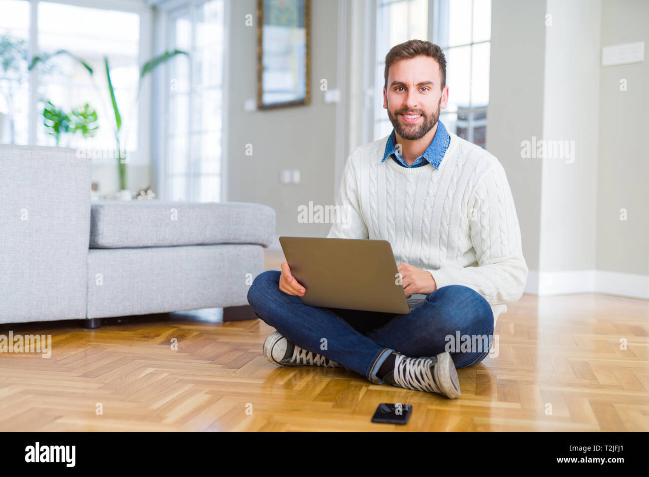 Handsome man wearing working using computer laptop with a happy and ...