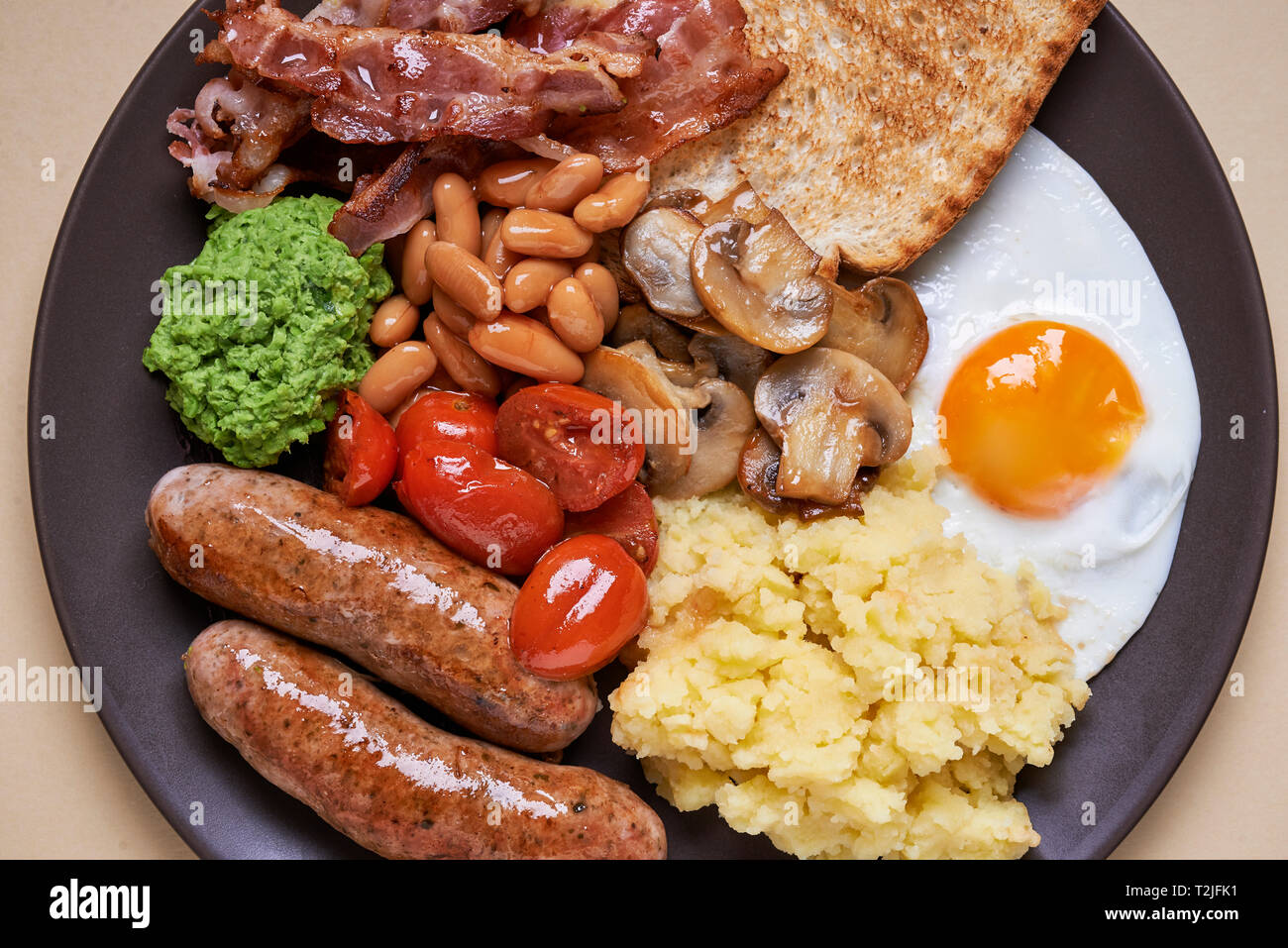 full english breakfast with eggs, sausages, potato, beans, bacon ...