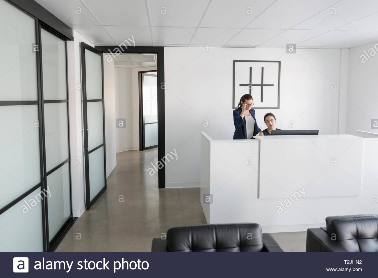 Businesswoman standing reception desk desk hi-res stock photography and ...