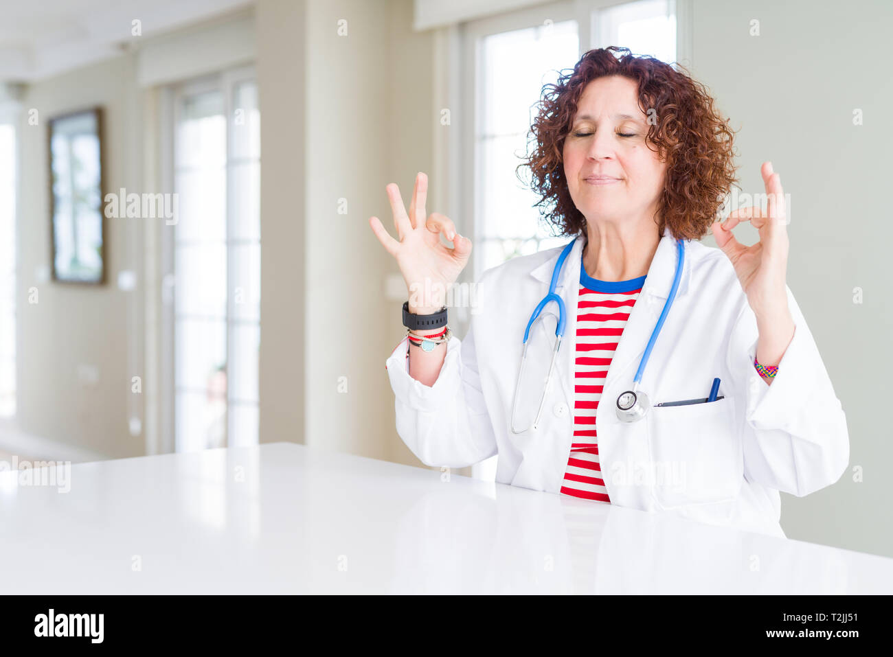 Senior doctor woman wearing medical robe at the clinic relax and ...