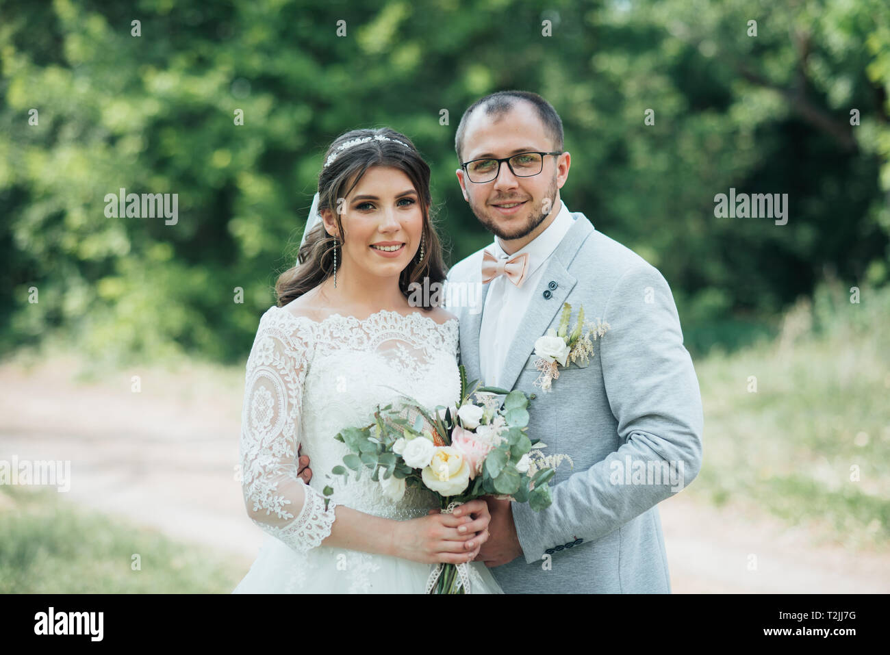 Wedding photo of the bride and groom in a gray-pink color on nature in ...