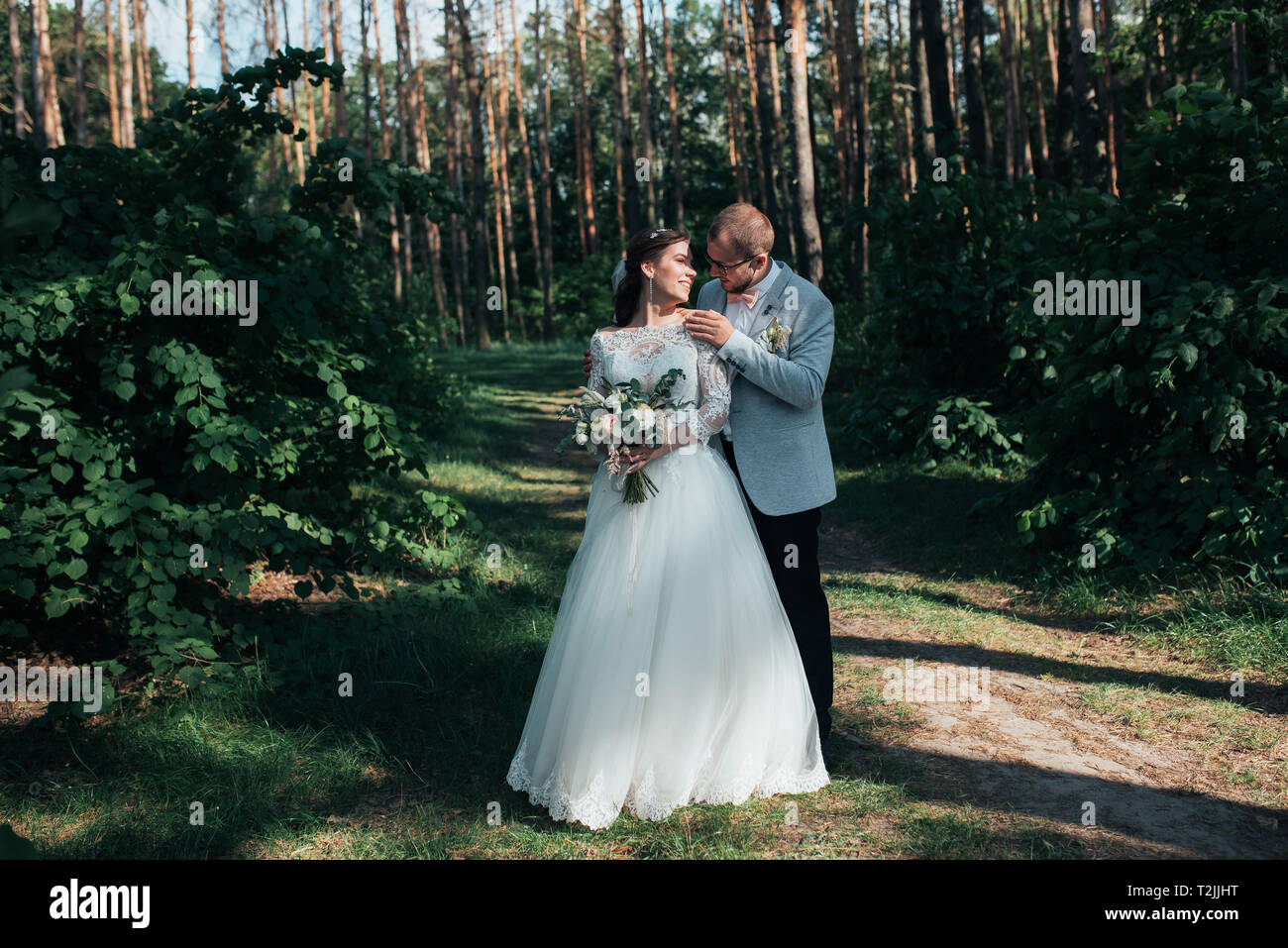 Wedding photo of the bride and groom in a gray-pink color on nature in ...