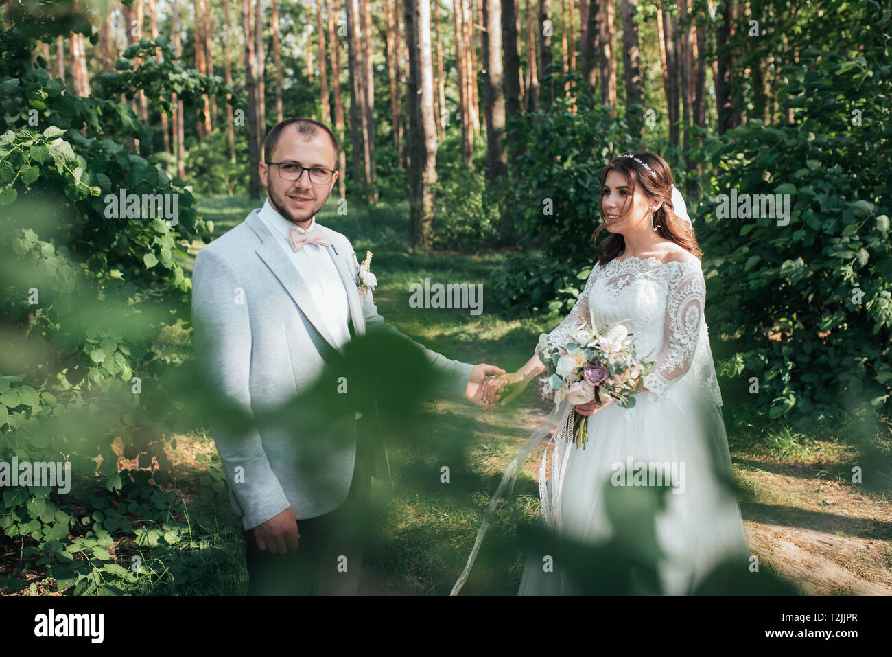Wedding photo of the bride and groom in a gray-pink color on nature in ...