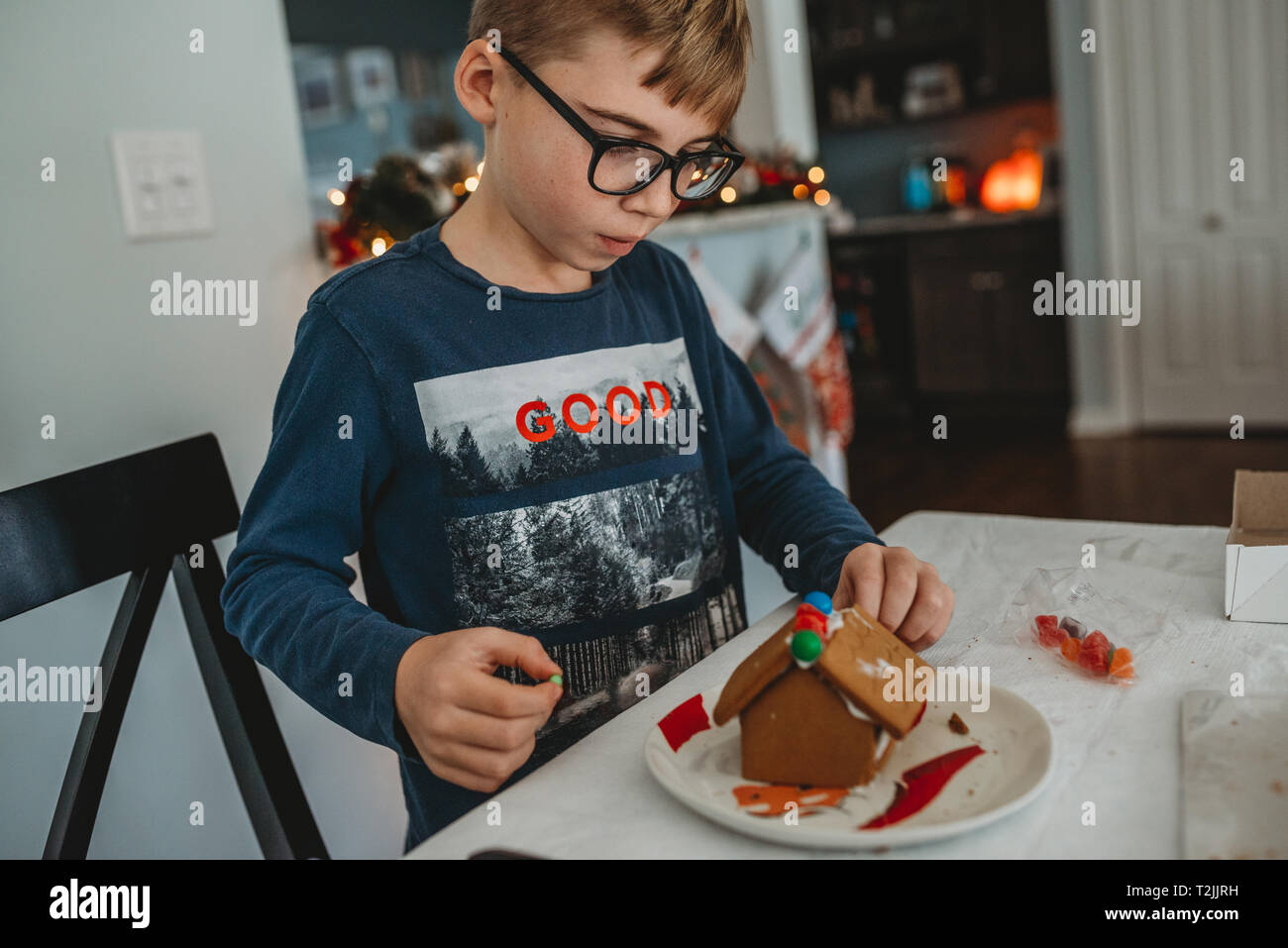Boy Decorating Gingerbread House Stock Photo - Alamy