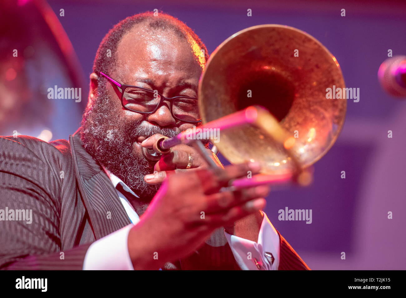 Member from Mangum & Company, a shout band, playing trombone on stage ...