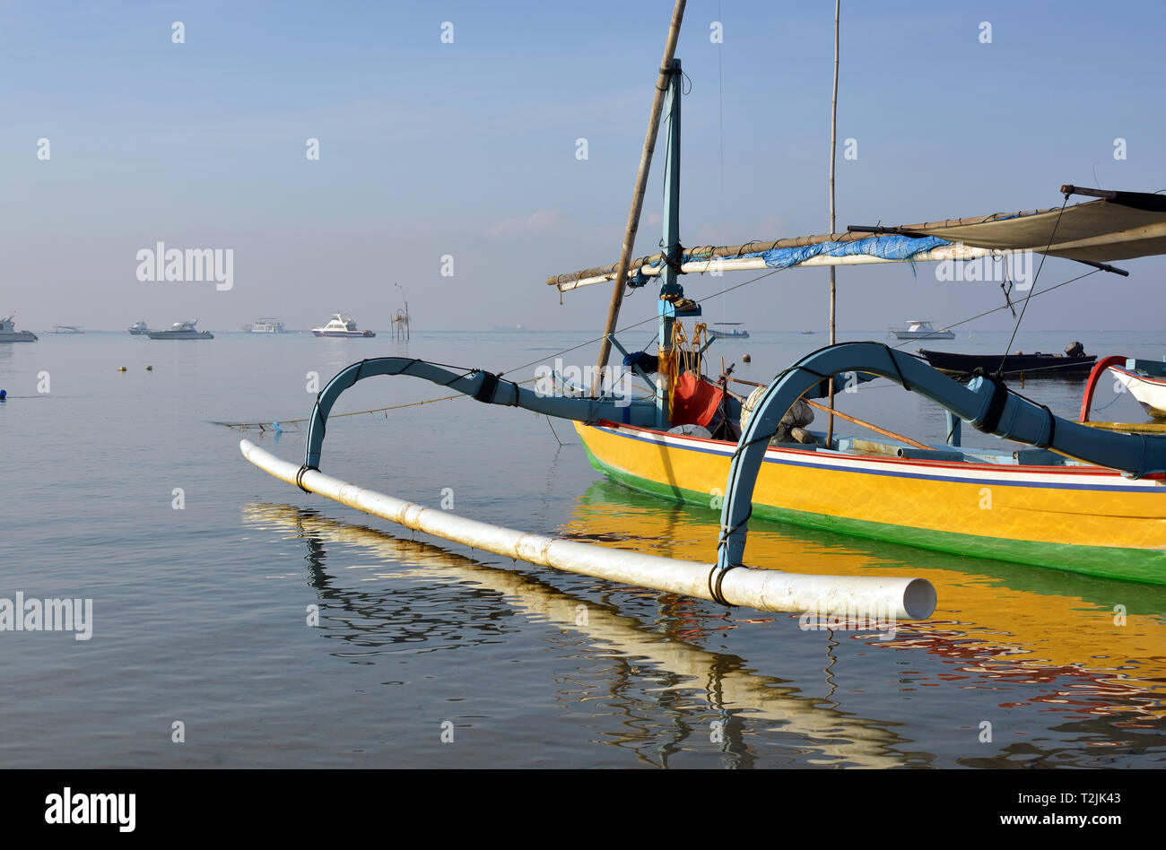 Brightly coloured outrigger Balinese fishing boat heading out To Sea at ...