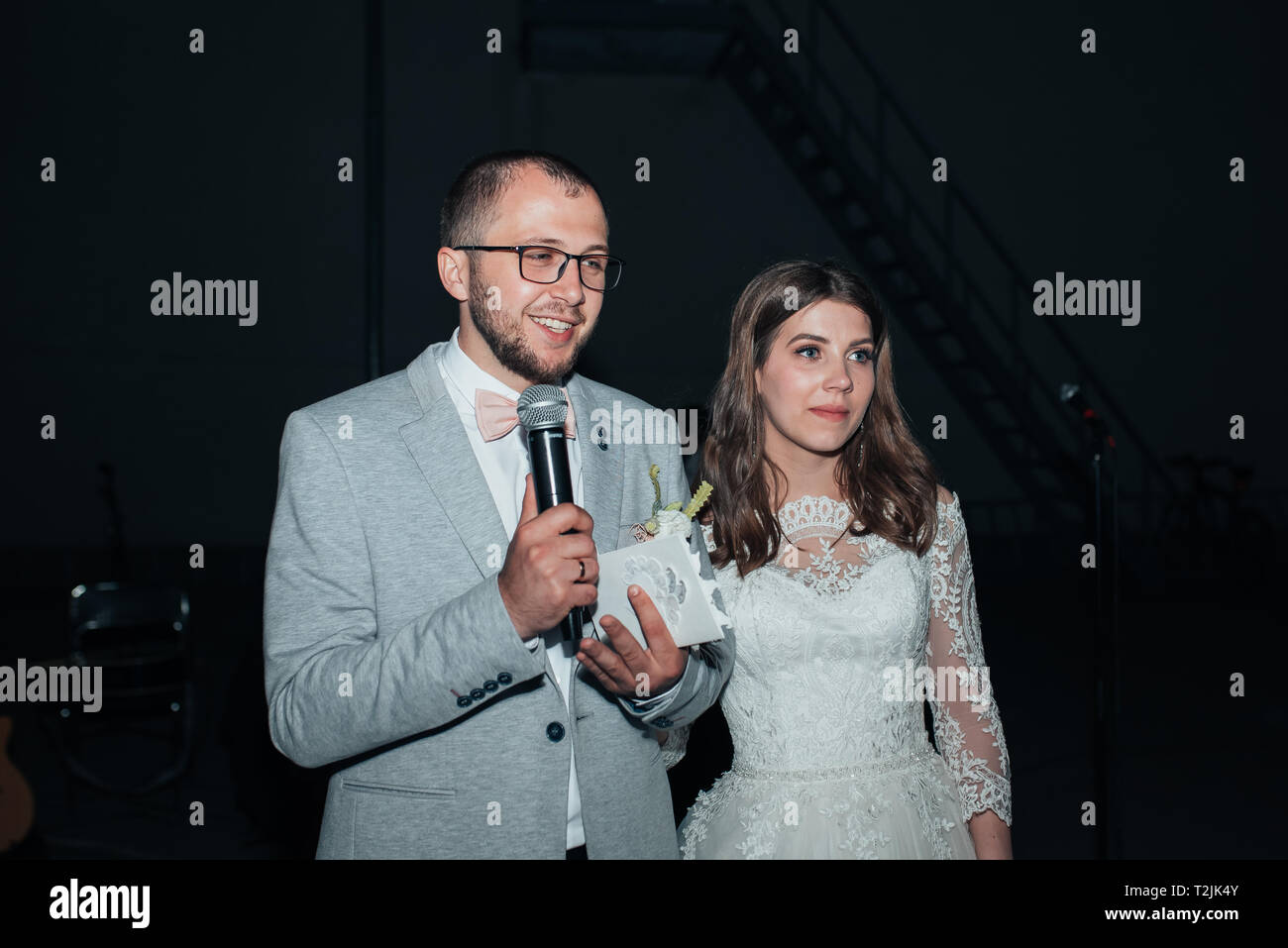 The bride and groom at the microphone party thank guests and parents ...