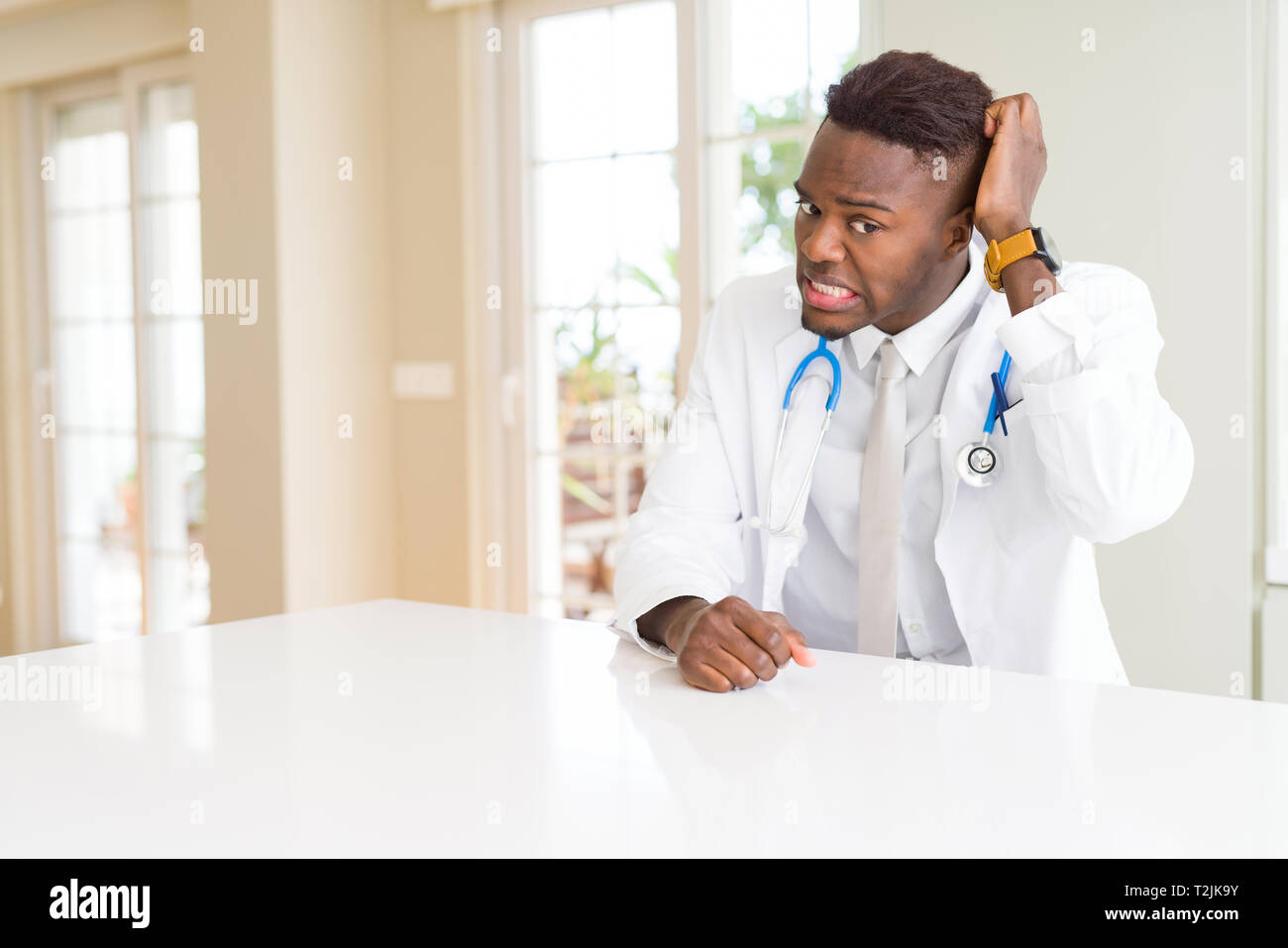 African american doctor man at the clinic confuse and wonder about ...