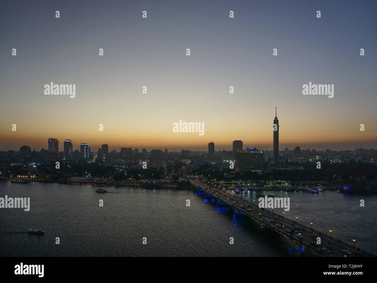 Cairo, Egypt: Cairo Tower and the Qasr el Nile Bridge at sunset. On ...