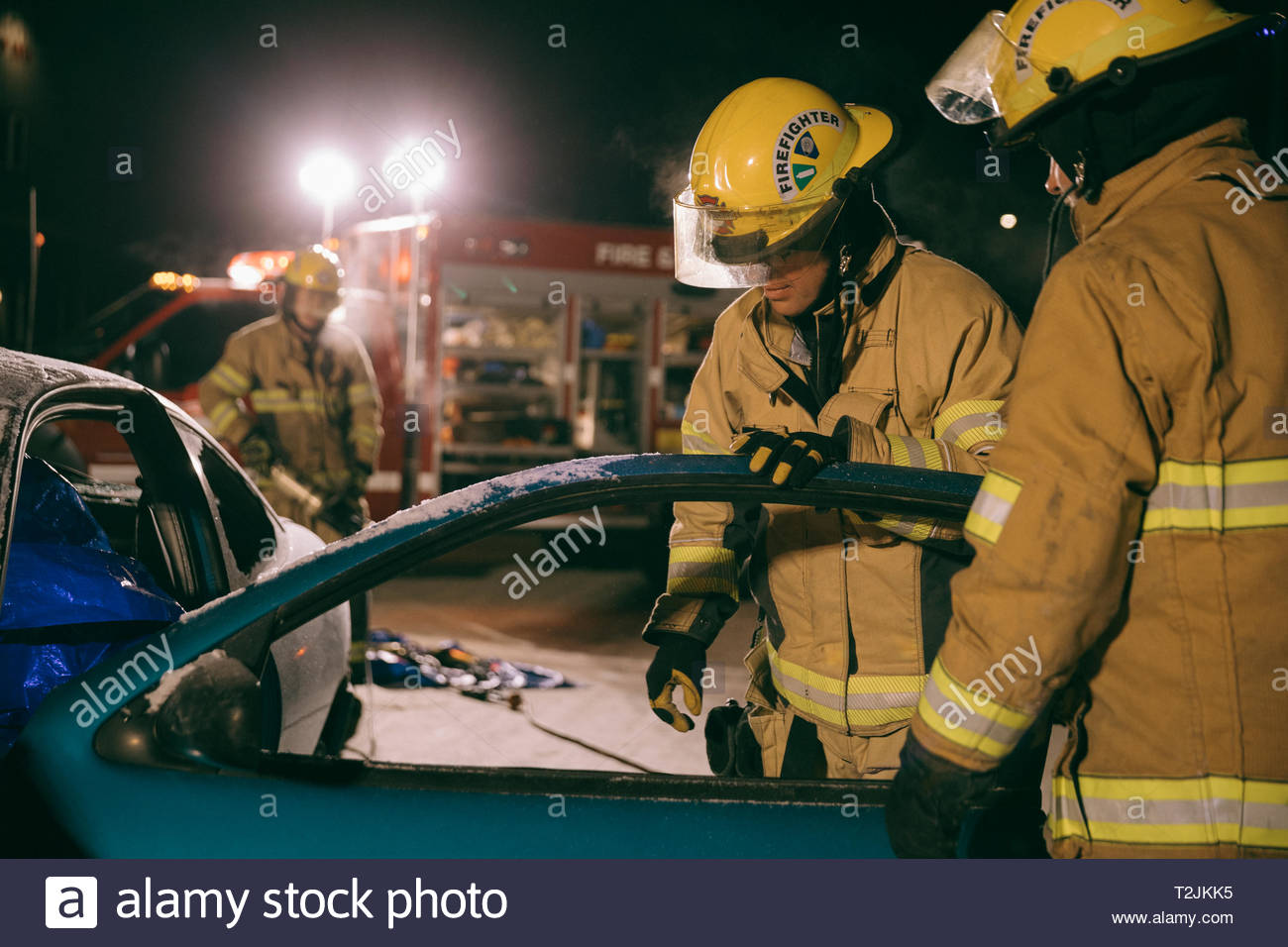 Firefighters at scene of car accident Stock Photo - Alamy