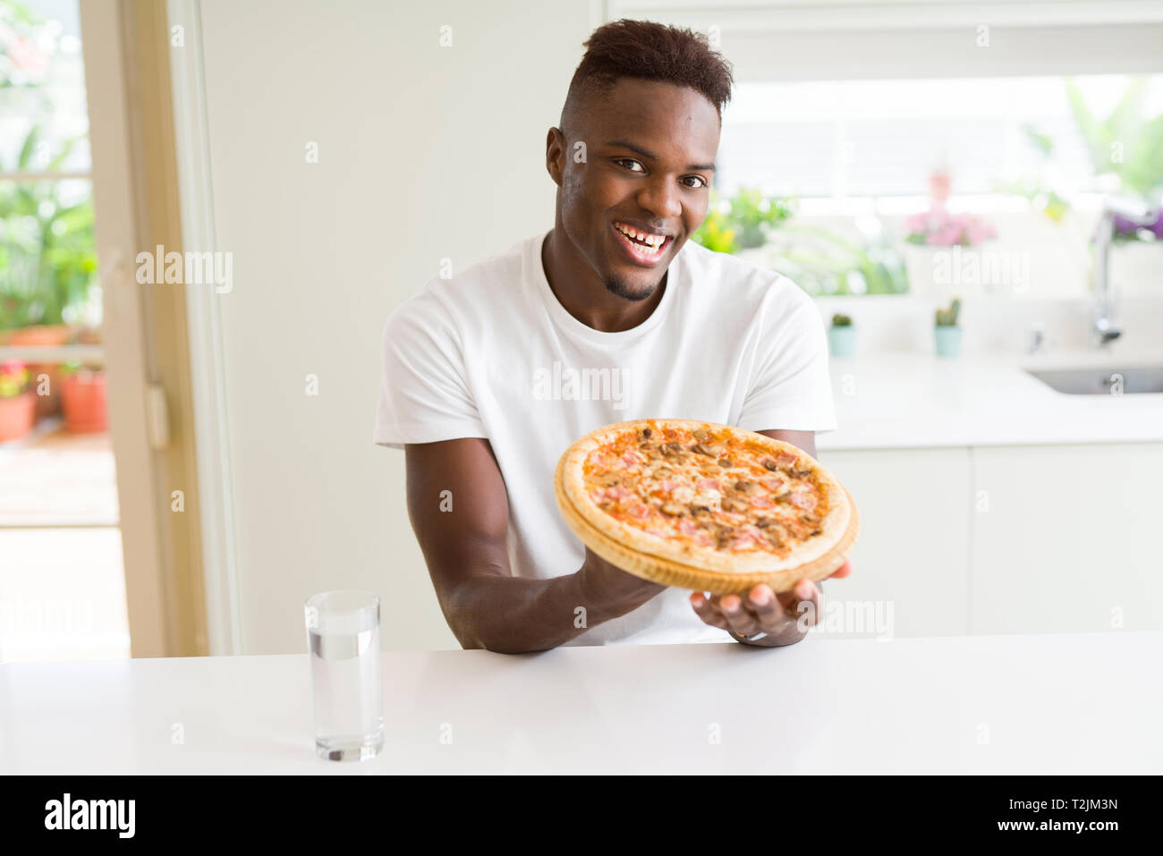Handsome black man holding pizza hi-res stock photography and images ...