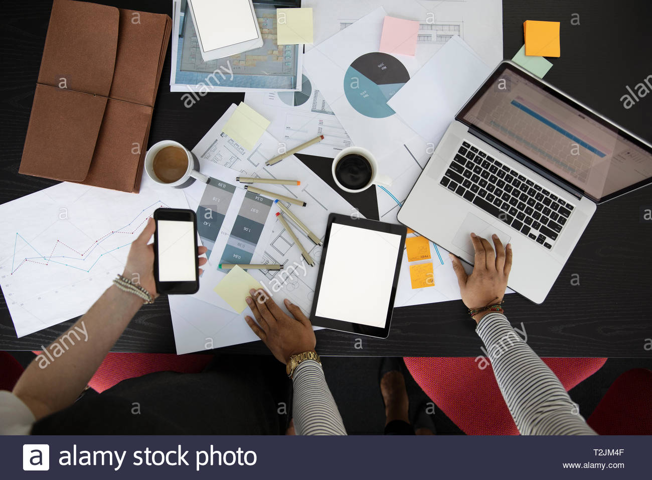 View from above business people strategizing, using technology Stock ...