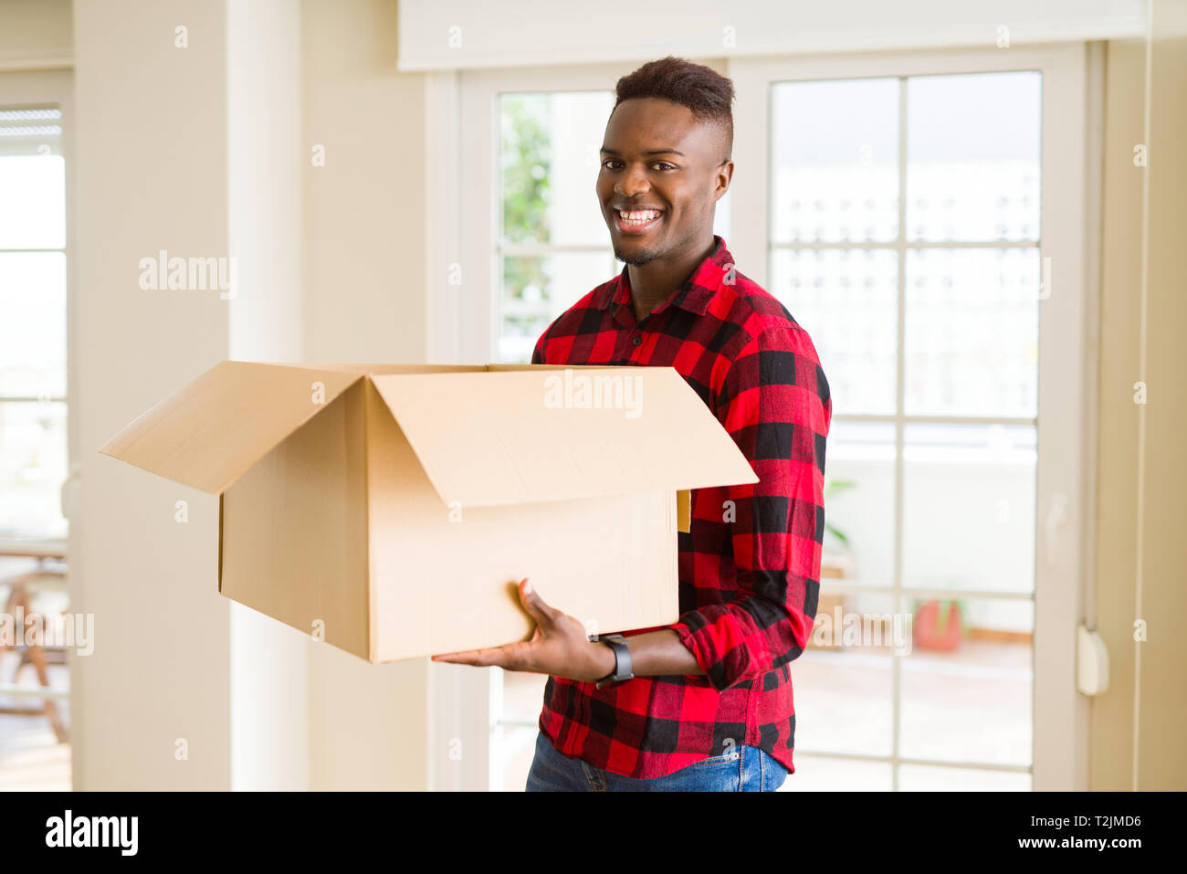 Adult african man packing boxes hi-res stock photography and images - Alamy