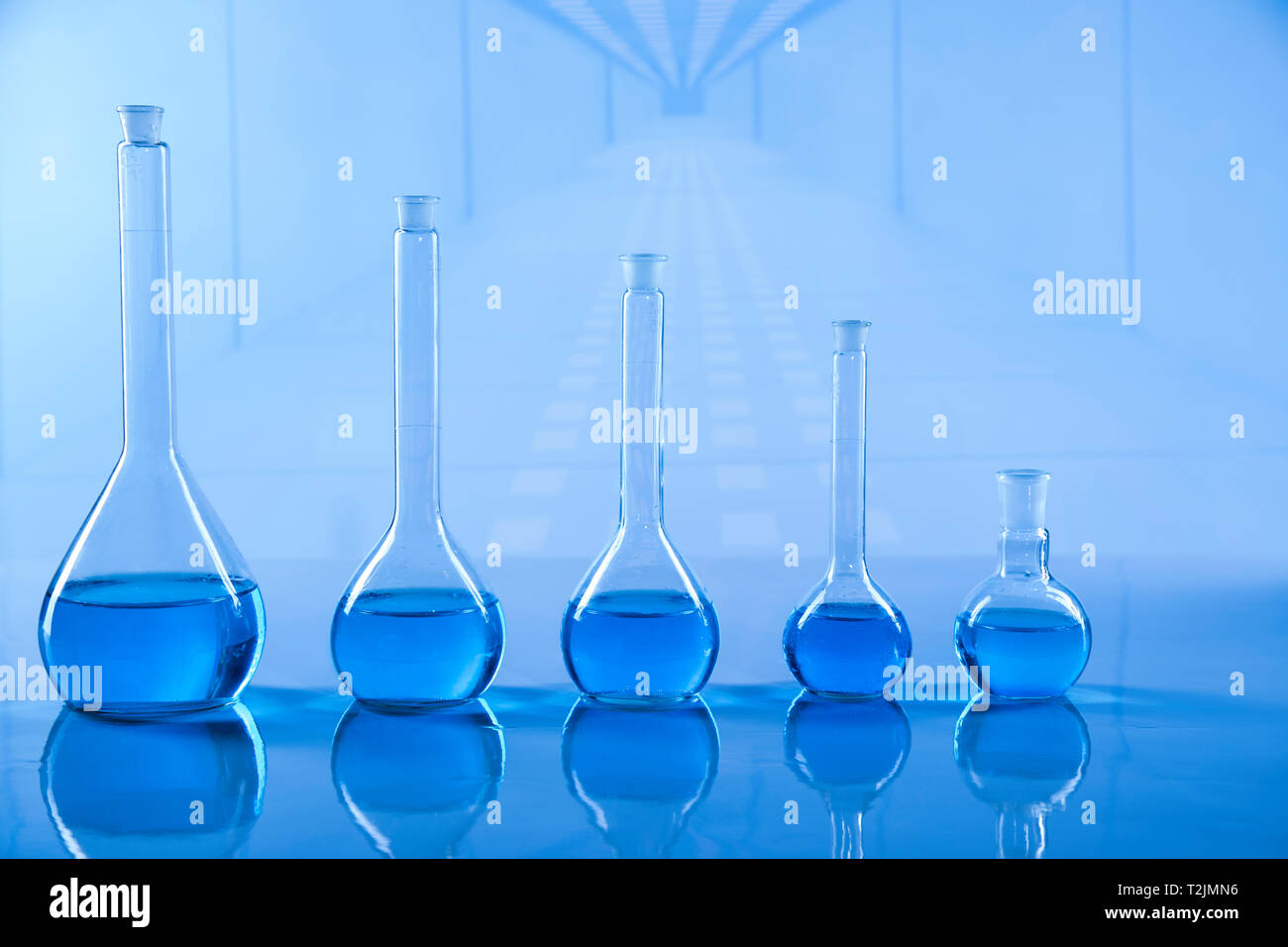 Laboratory beakers,Science experiment, blue background Stock Photo - Alamy