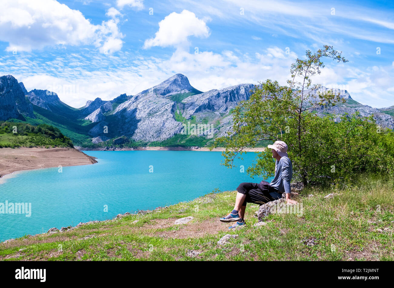 Man on the lake shore in the mountains on a summer day. Cantabrian ...