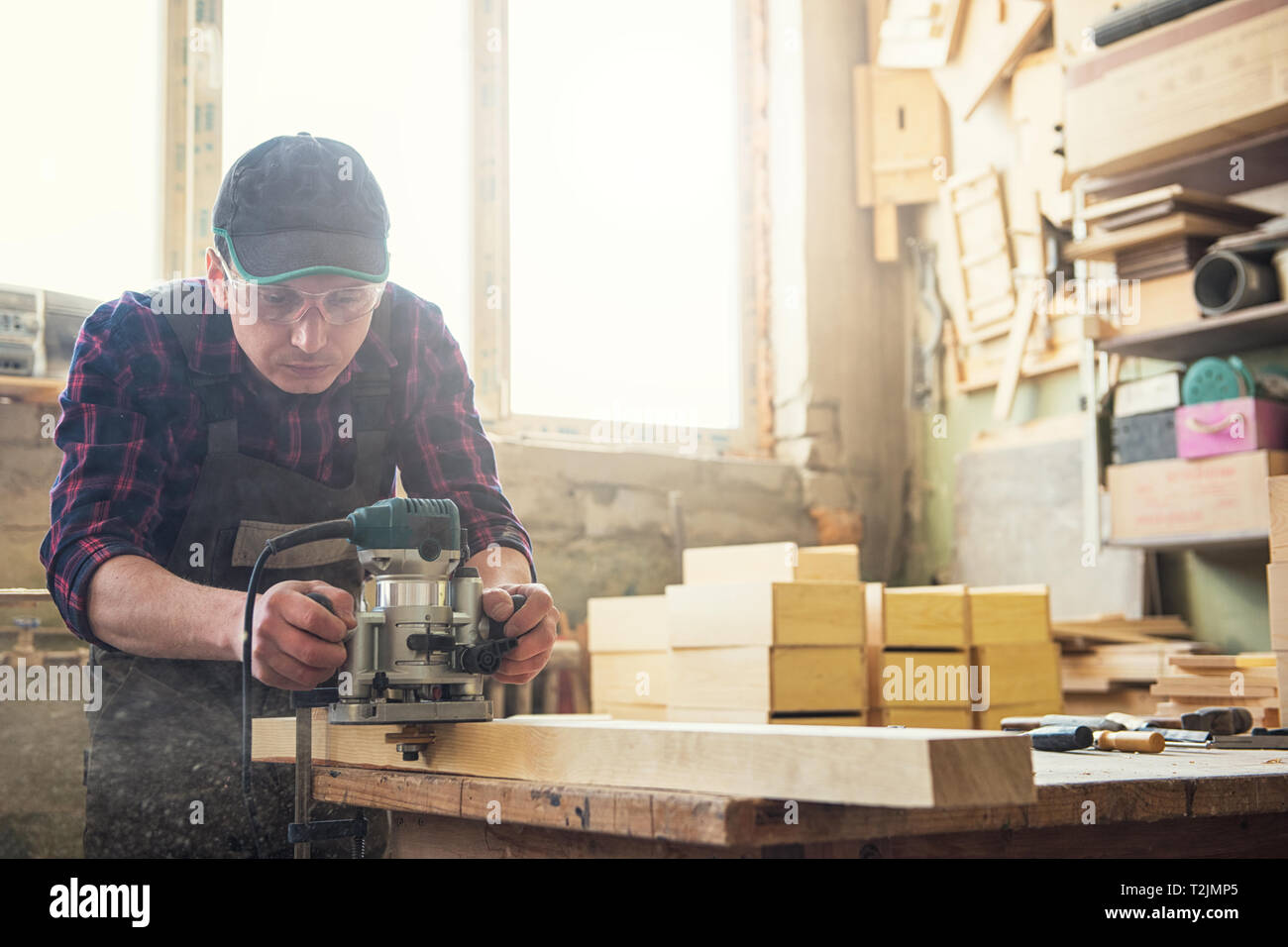 Worker grinds the wood box of angular grinding machine. Profession ...