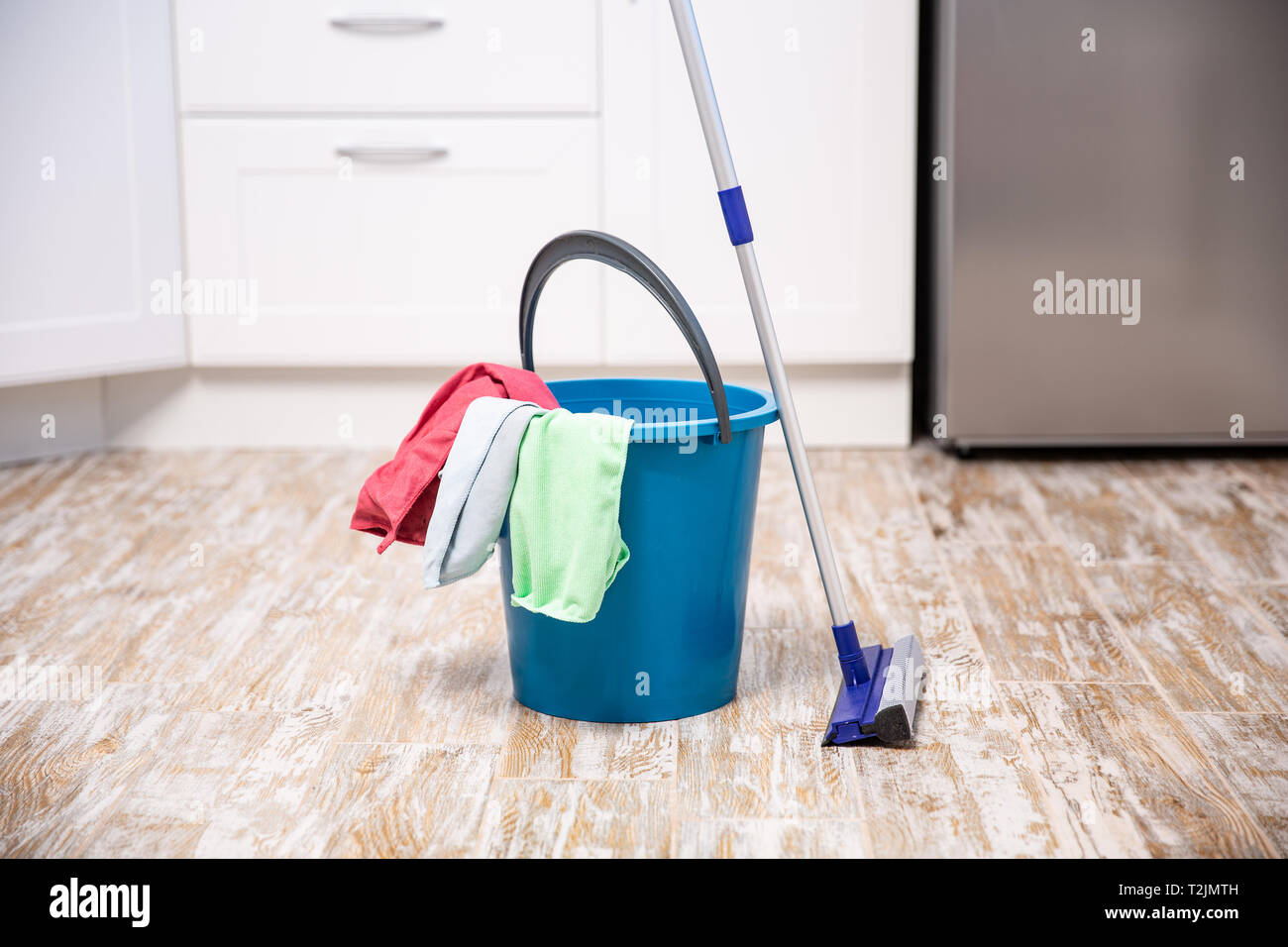Plastic bucket with cleaning supplies in home. cleaning the kitchen ...