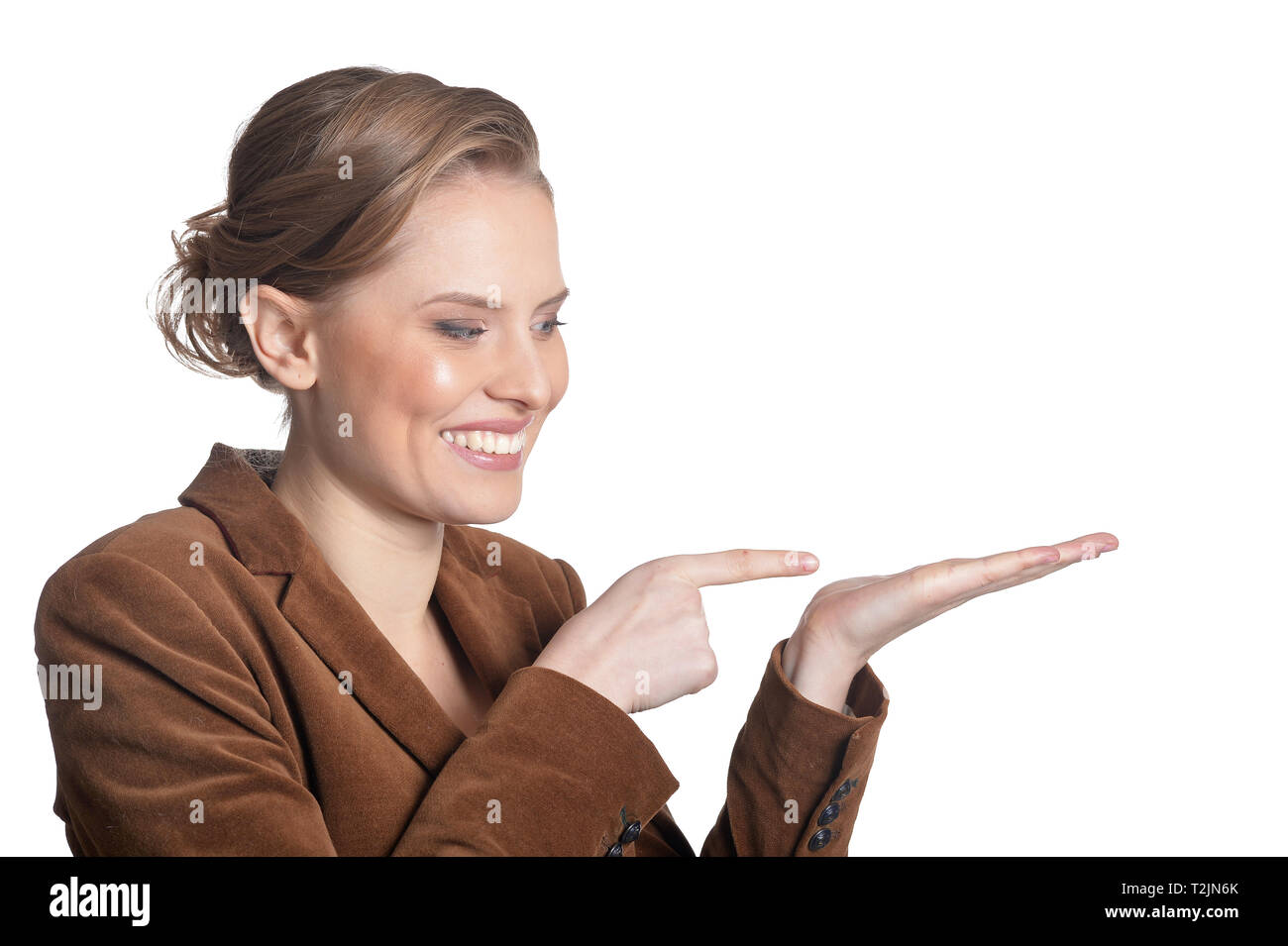 Portrait of smiling young woman pointing isolated on white background ...
