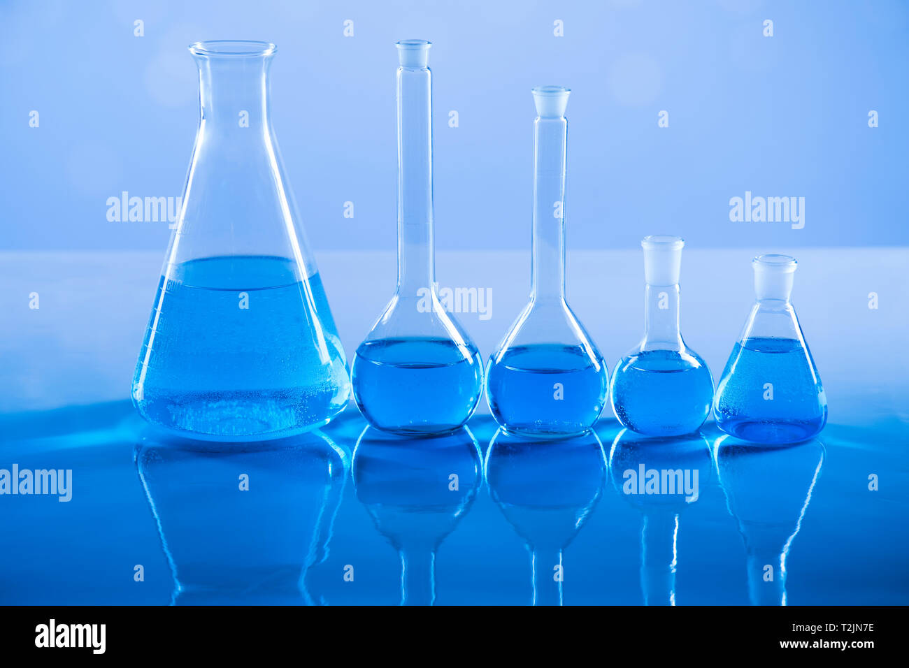 Laboratory beakers,Science experiment, blue background Stock Photo - Alamy