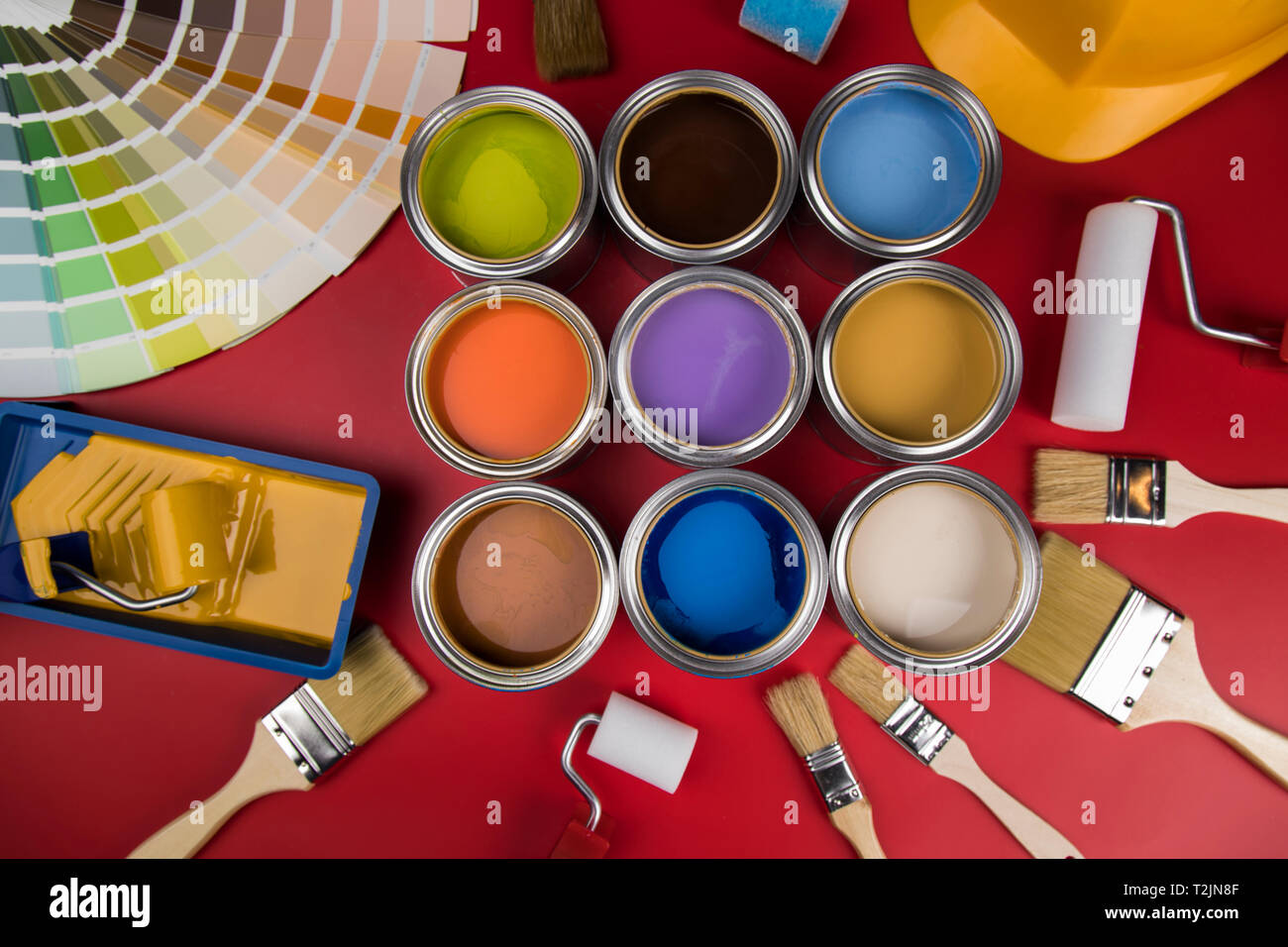 Open buckets with a paint and brush, red background Stock Photo - Alamy
