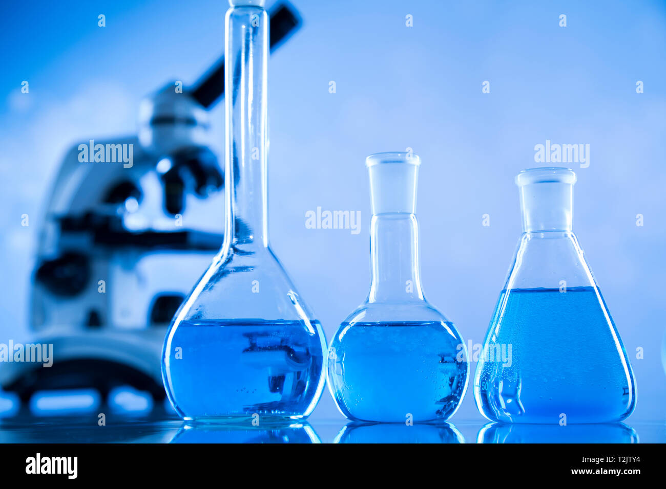 Laboratory beakers,Science experiment, blue background Stock Photo - Alamy