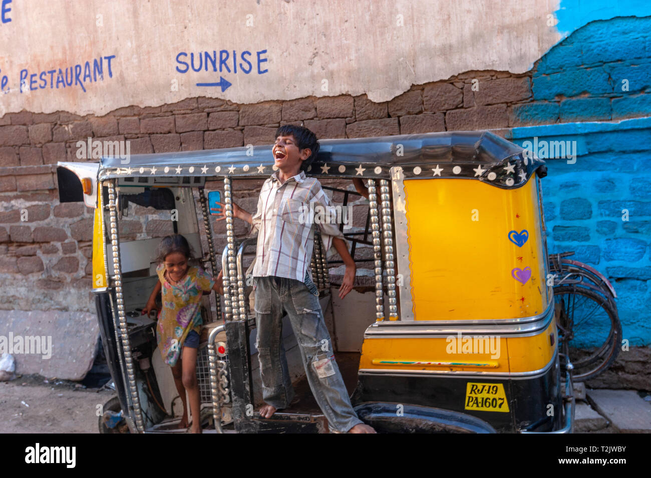 Children laughing in a rickshaw with a girl in Jodhpur, Rajasthan ...